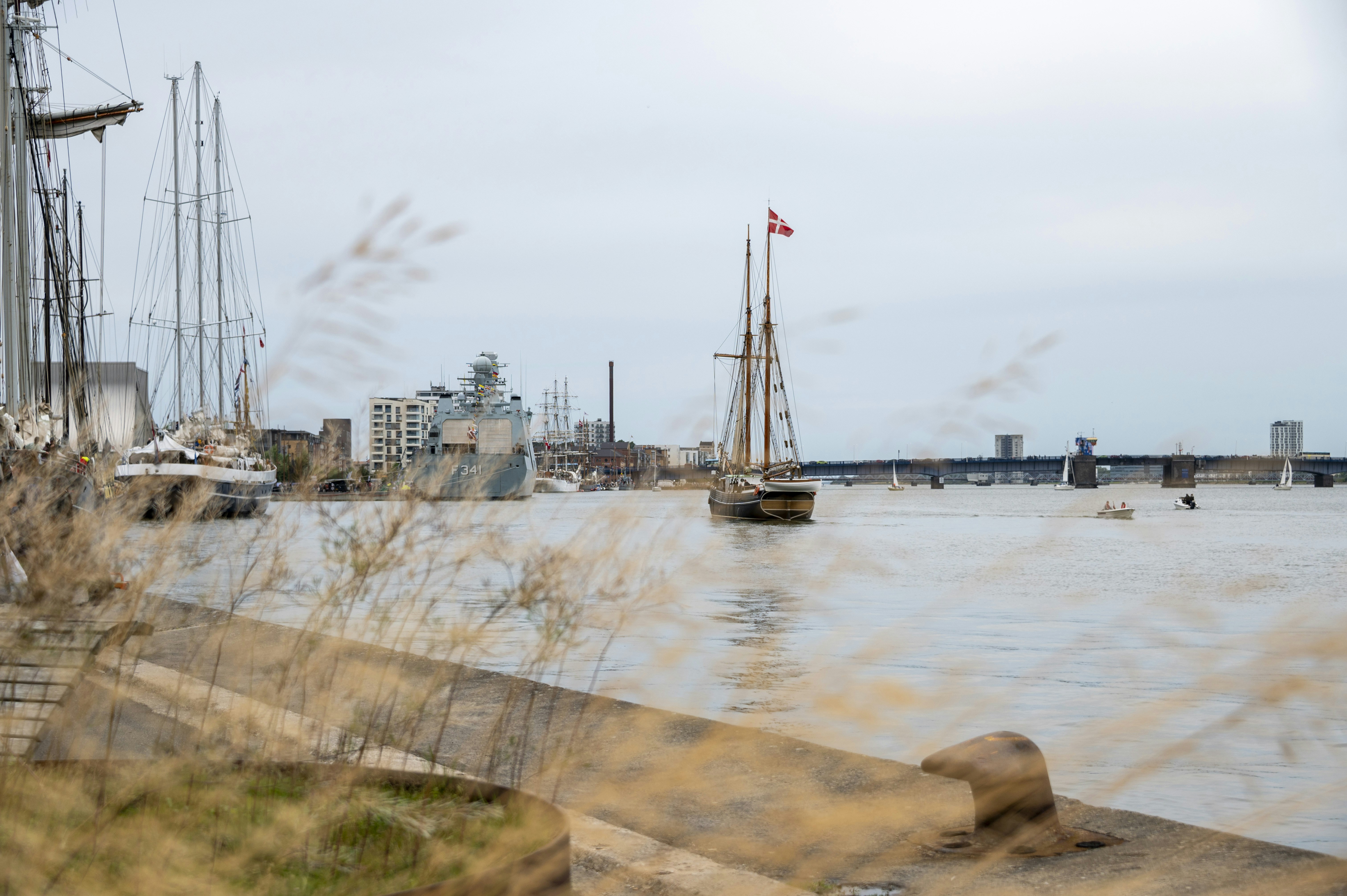 Sailing through a harbor breeze beneath a distant skyline