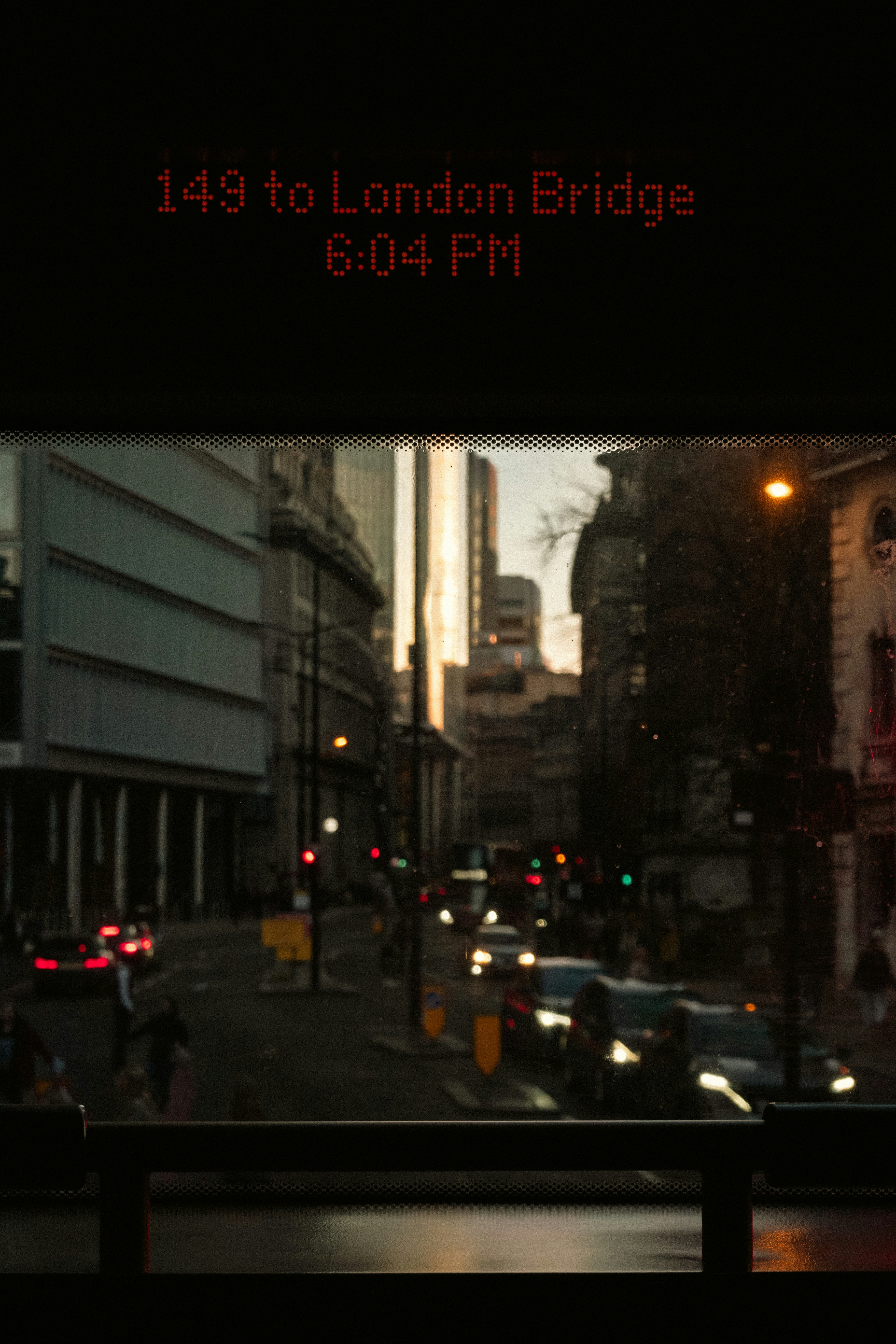 Dusk through the City Glass: Evening Traffic Beyond the Rail