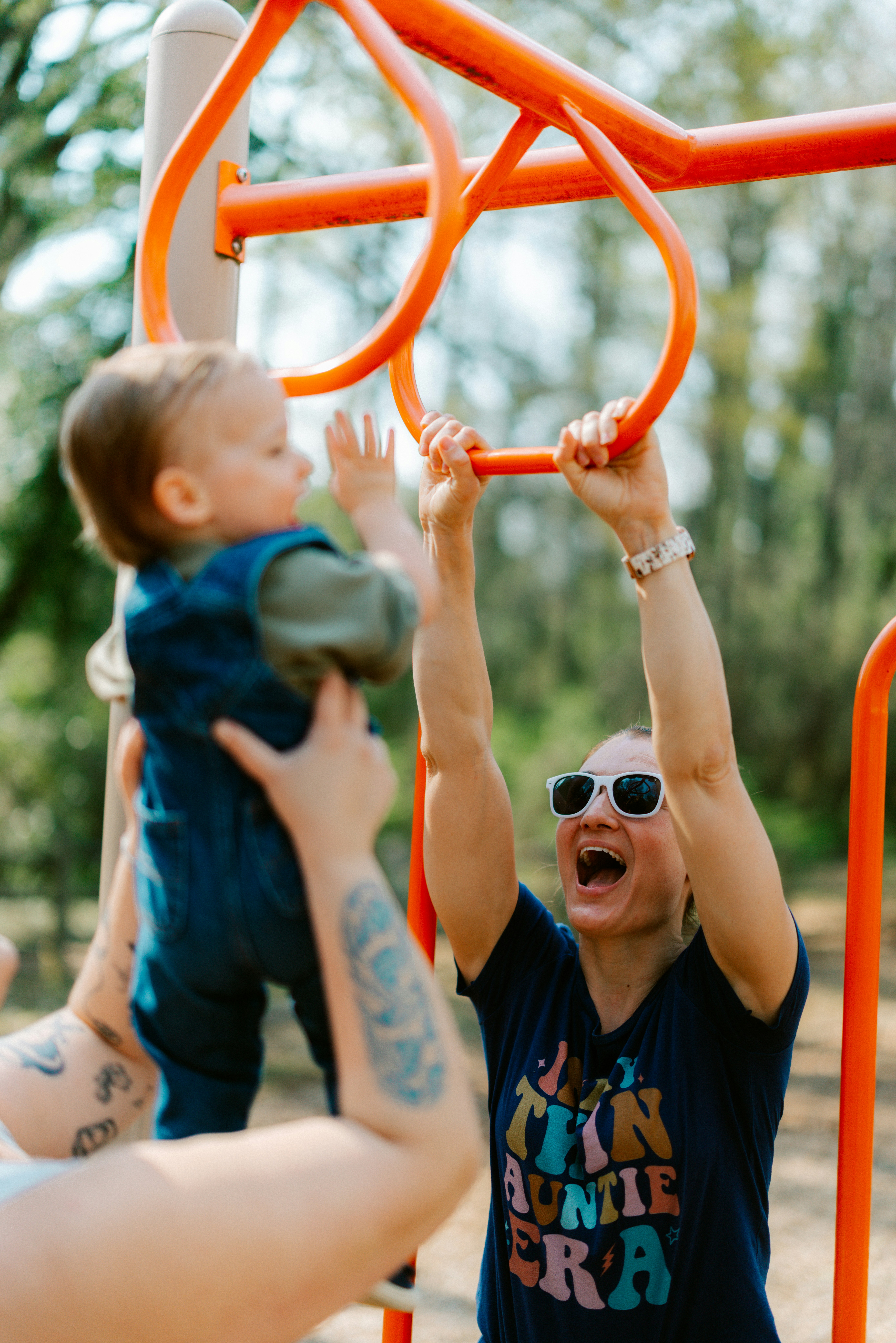 Joyful Hang-Time: A Parent Elevates a Tiny Climber
