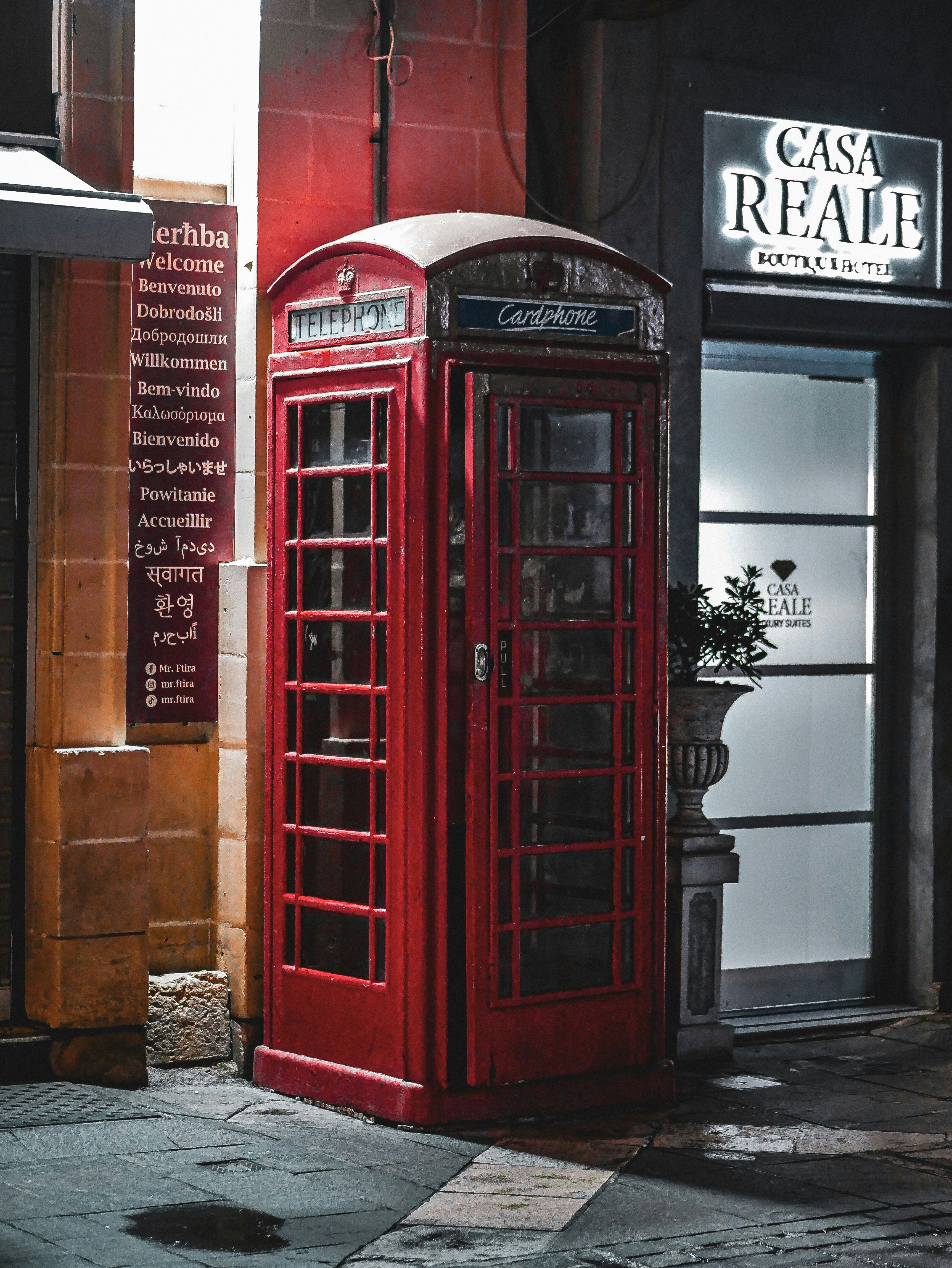 Red Telephone Box on a Lively Urban Corner
