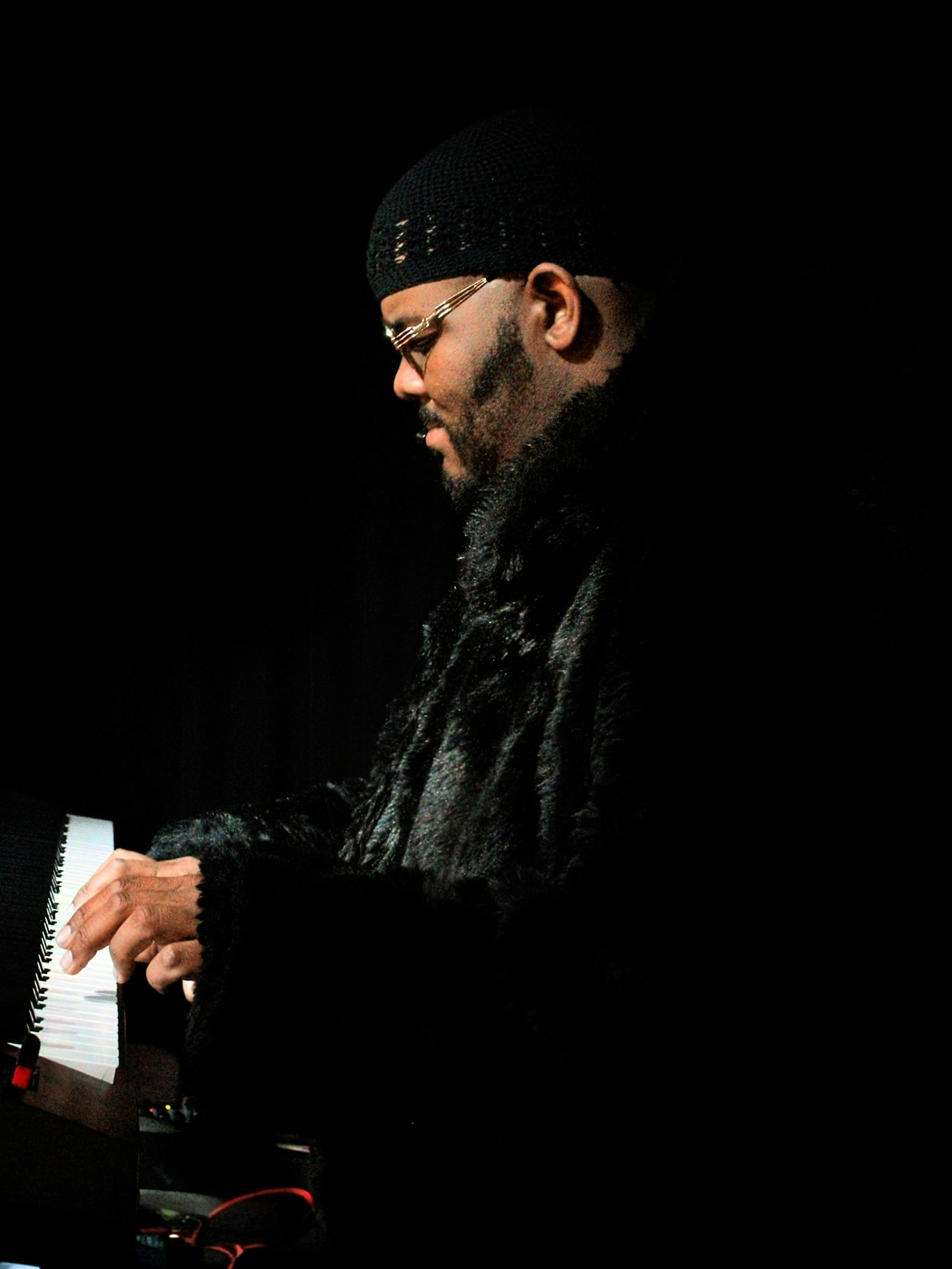 Focused on the Keys: Portrait of a Keyboardist in Shadowed Silence
