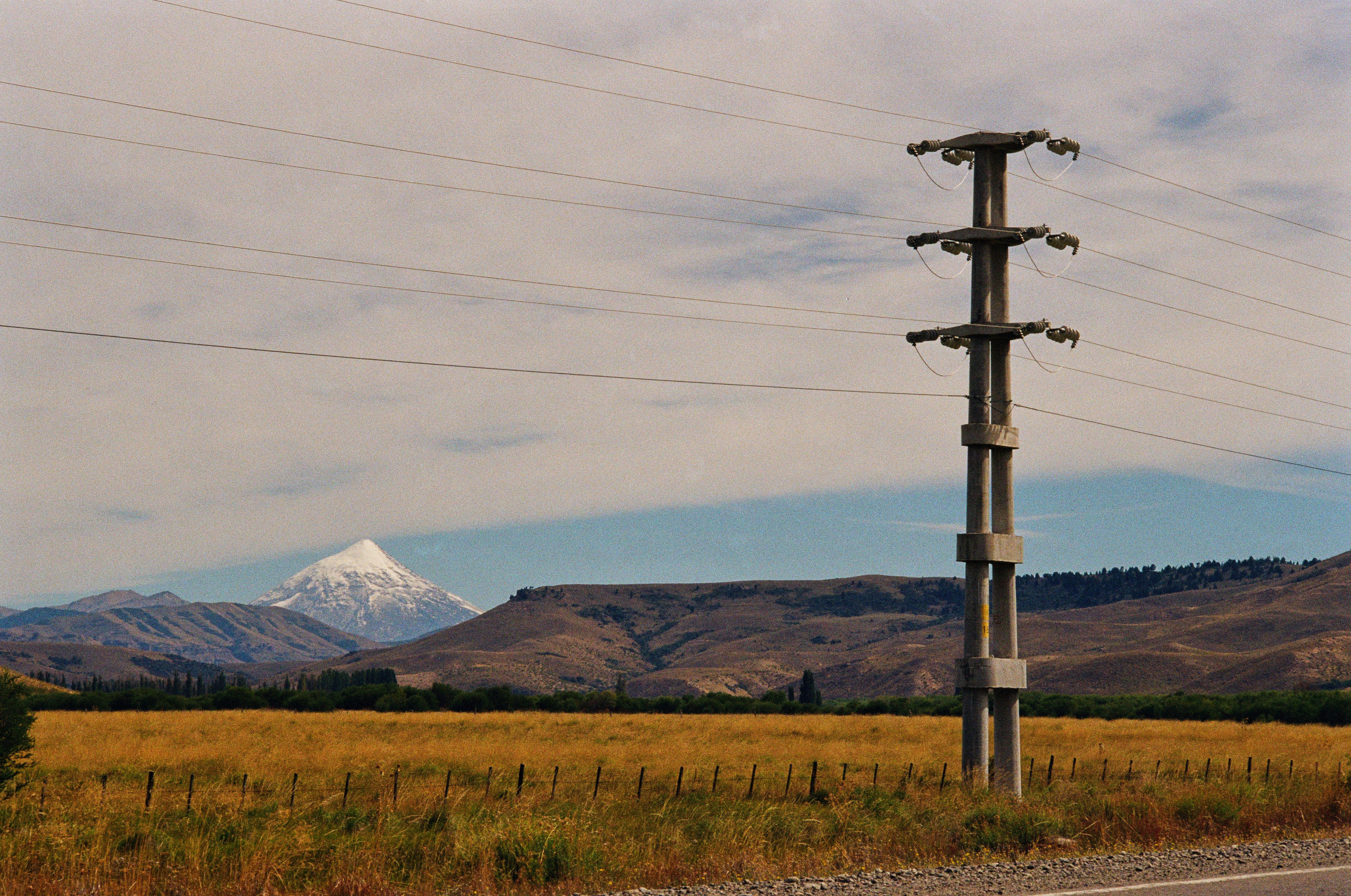 High Voltage Horizon: A Steel Monolith against Snowy Peaks