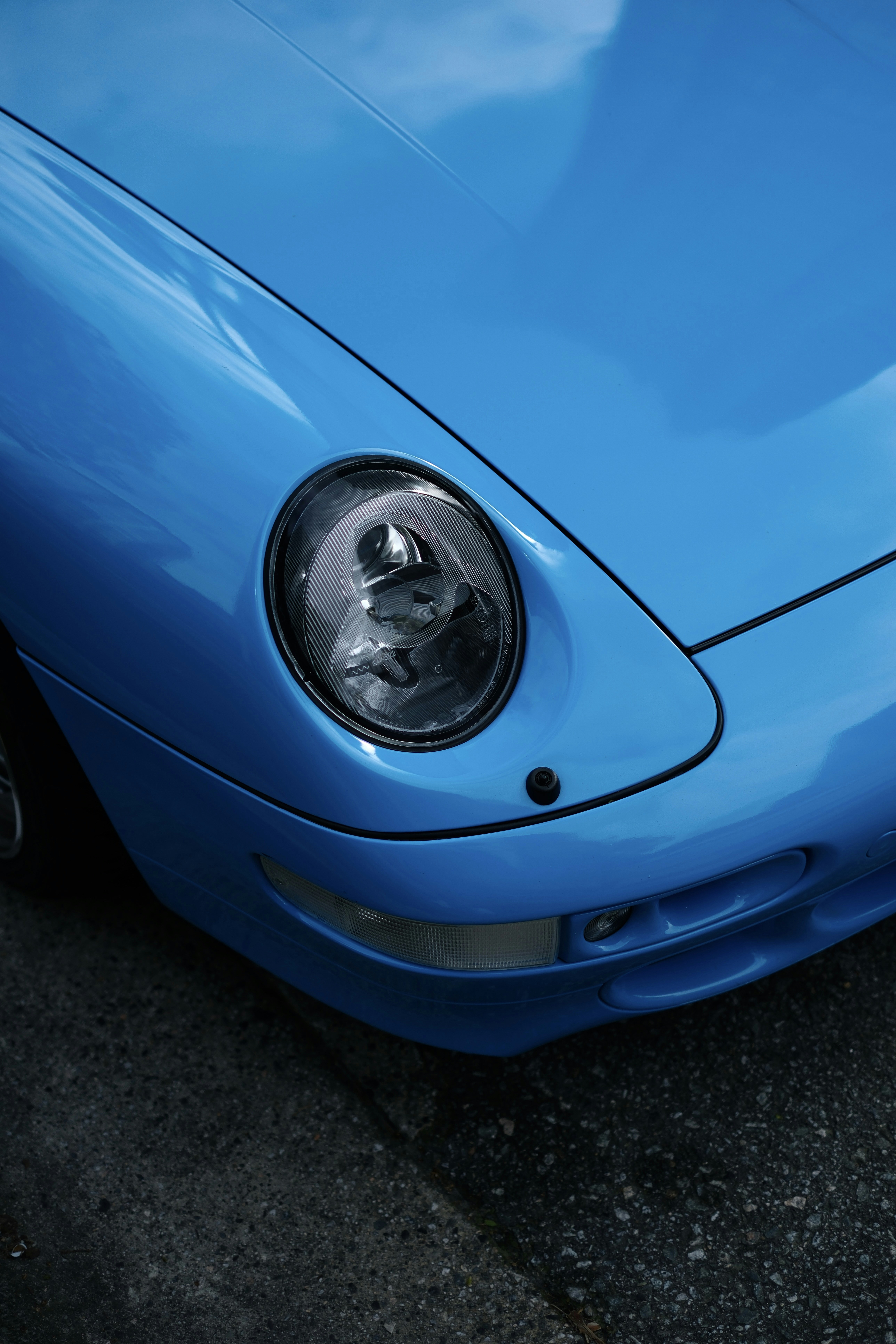 Blue Curves: The Front Quarter of a Porsche Under a Summer Sky