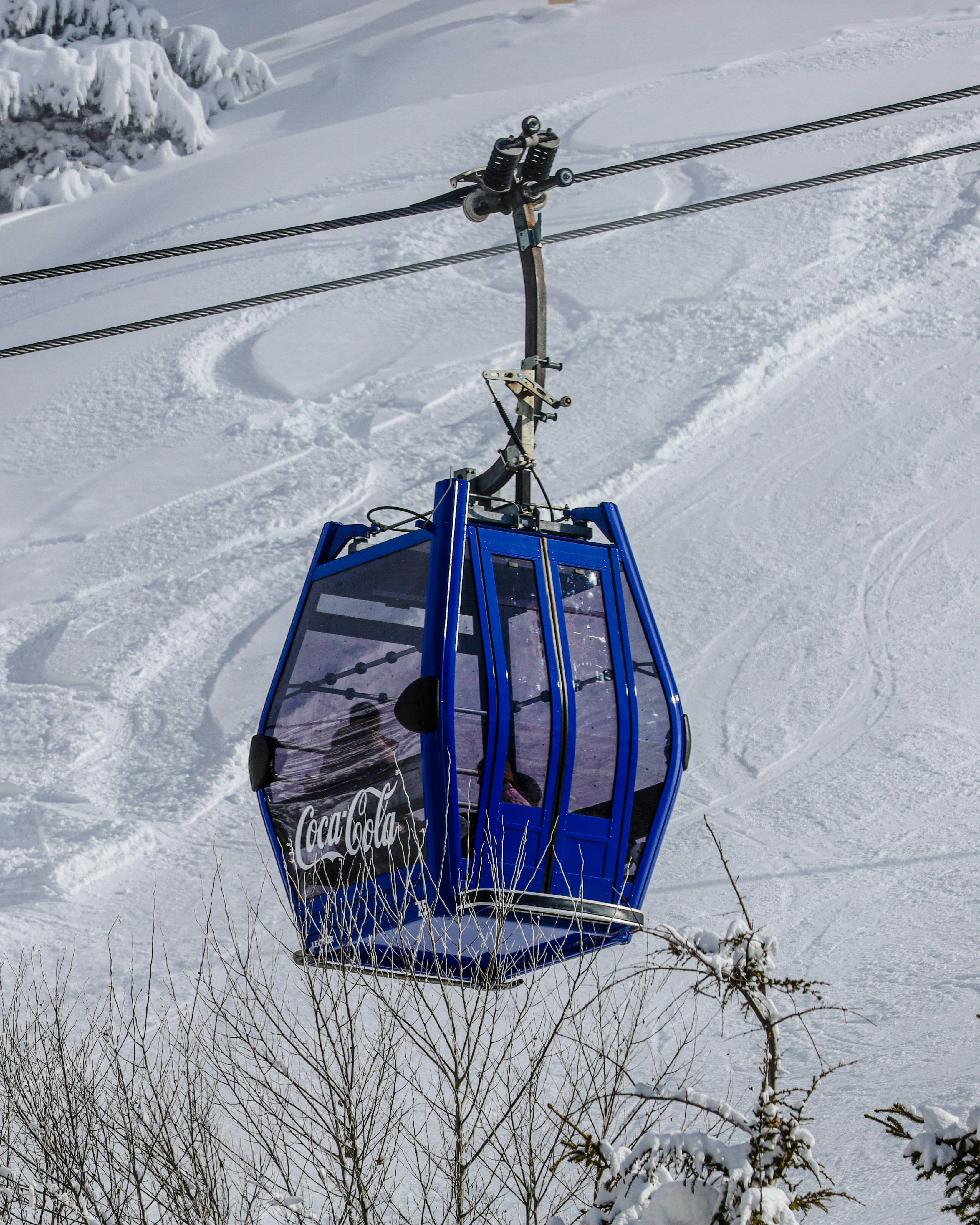 Blue Gondola Over Snow: A Quiet Lift Amid Alpine Silence