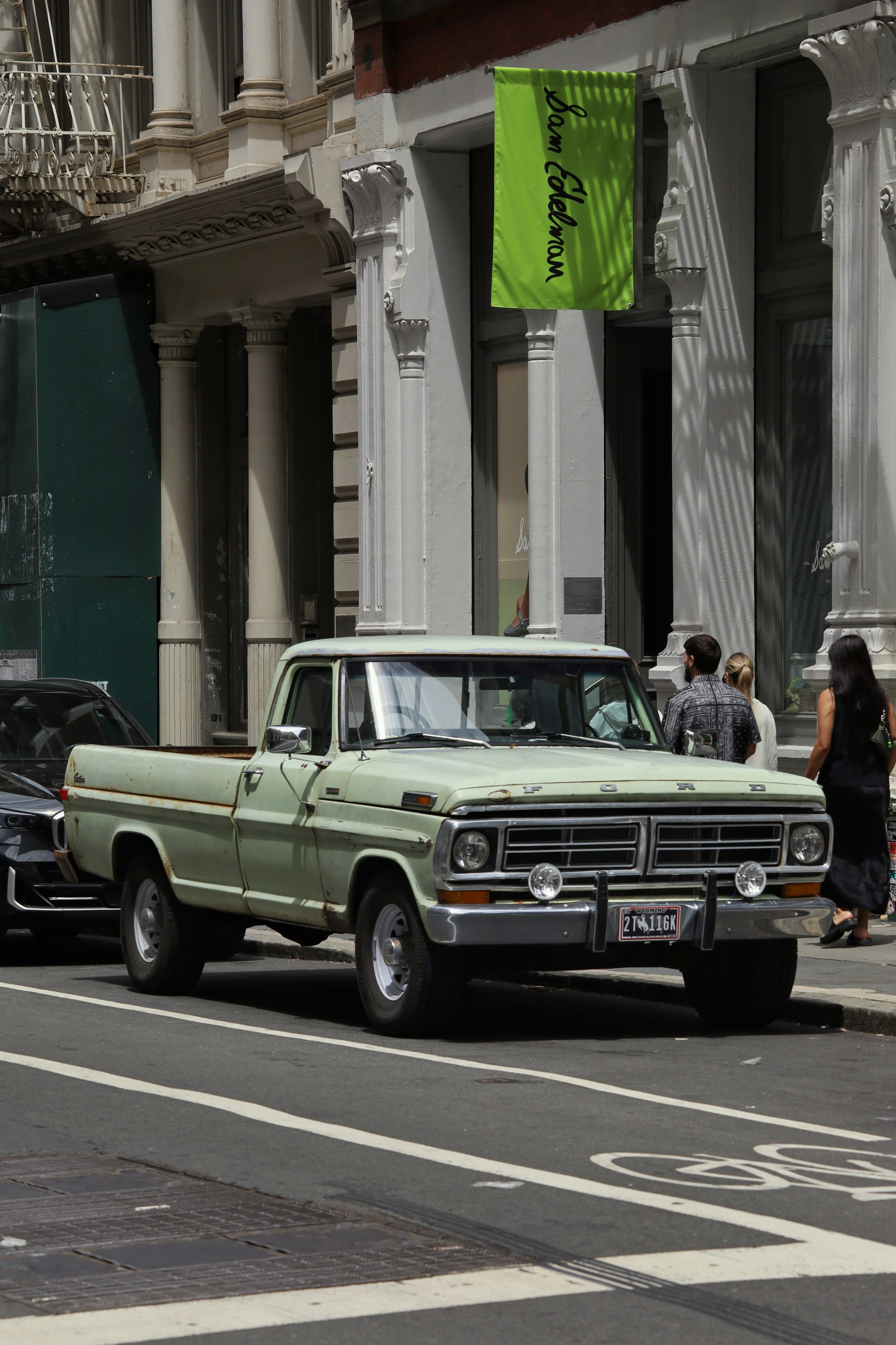 Vintage Green Pickup Under City Banner