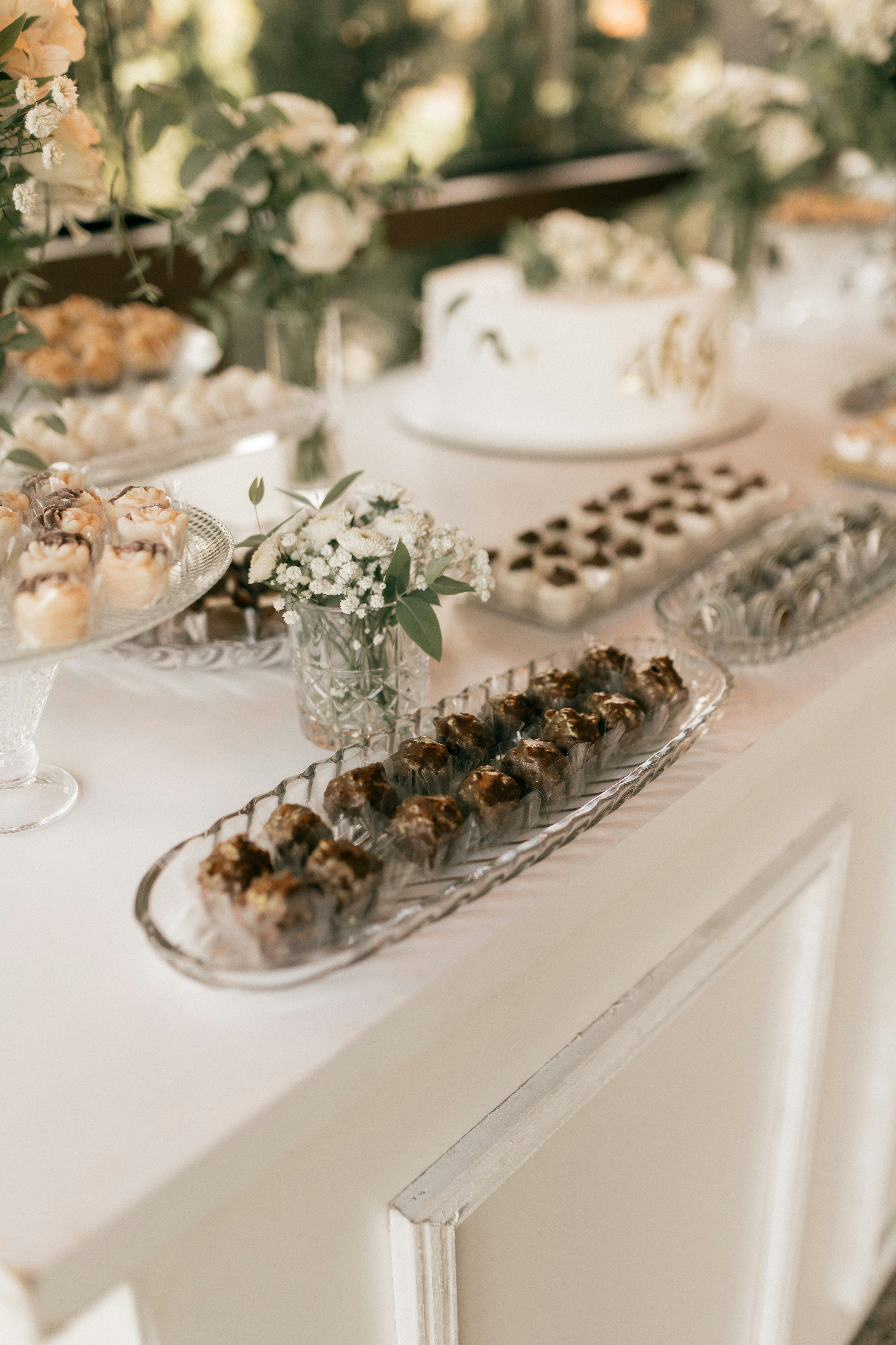 Sweet display: a row of chocolate-topped bites on a marble-bar dessert table