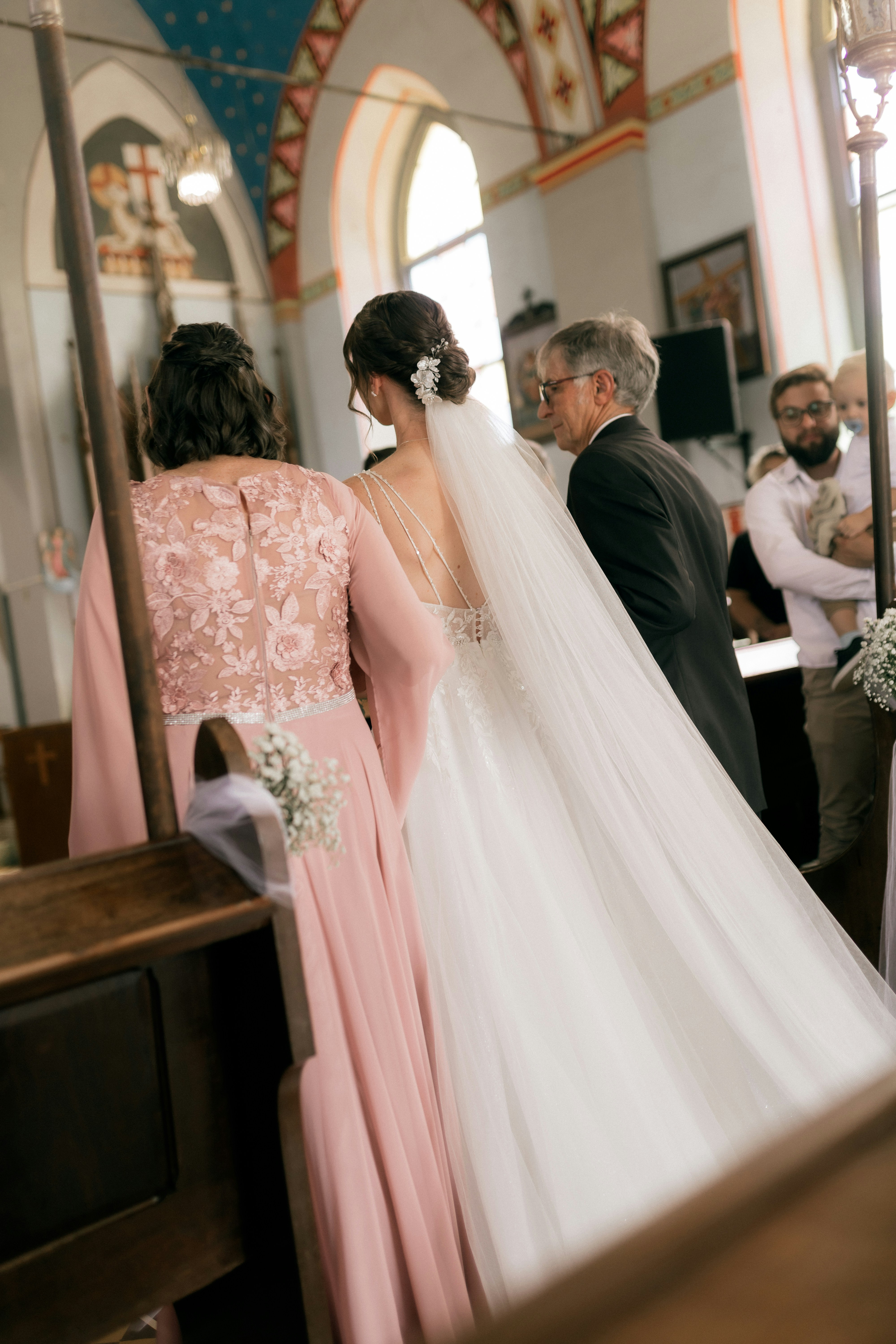 Veiled March Down the Aisle: A Bride Led by Loved Ones