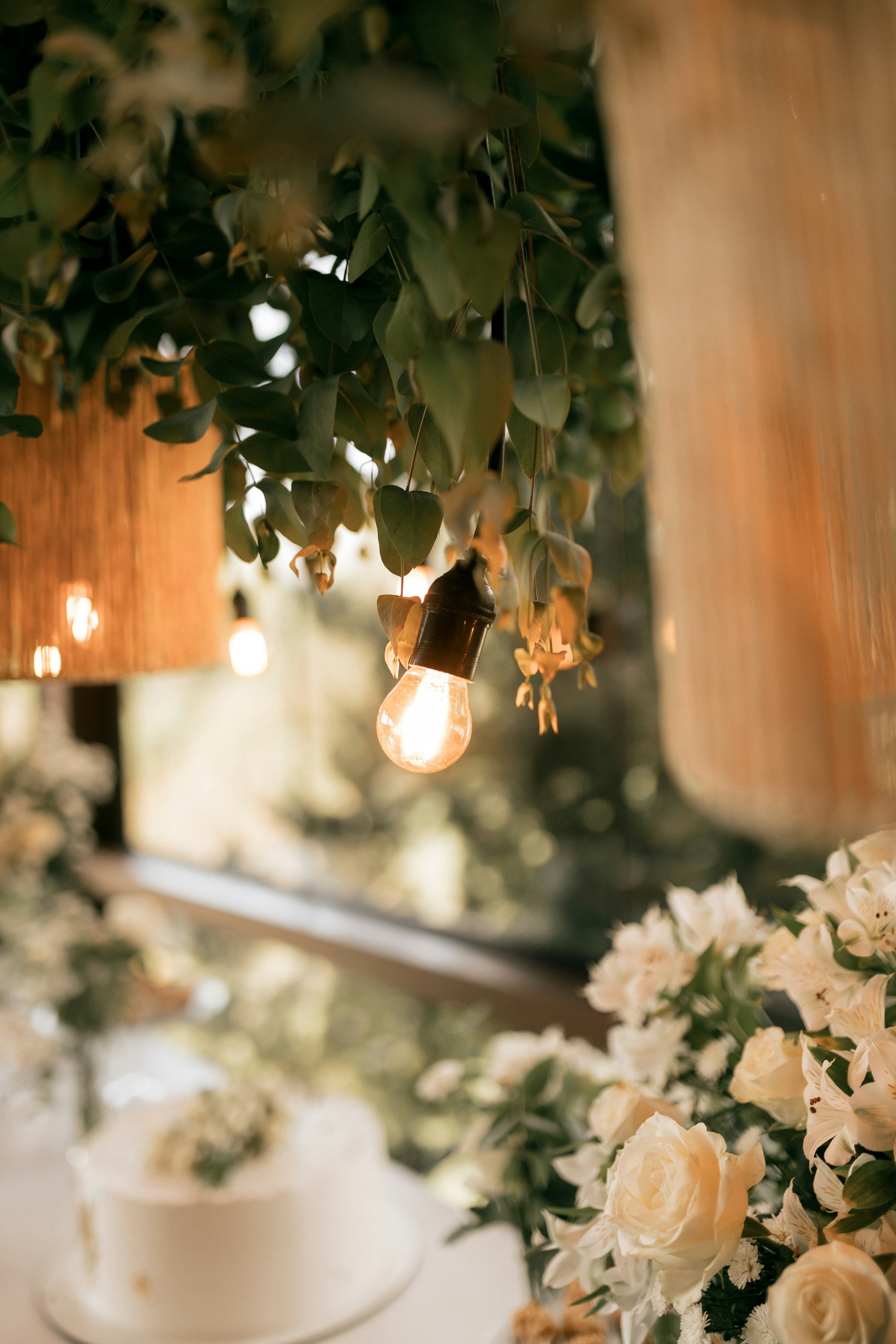 Glow in the Indoor Garden: An Illuminated Bulb Among Foliage and Floral Arrangements