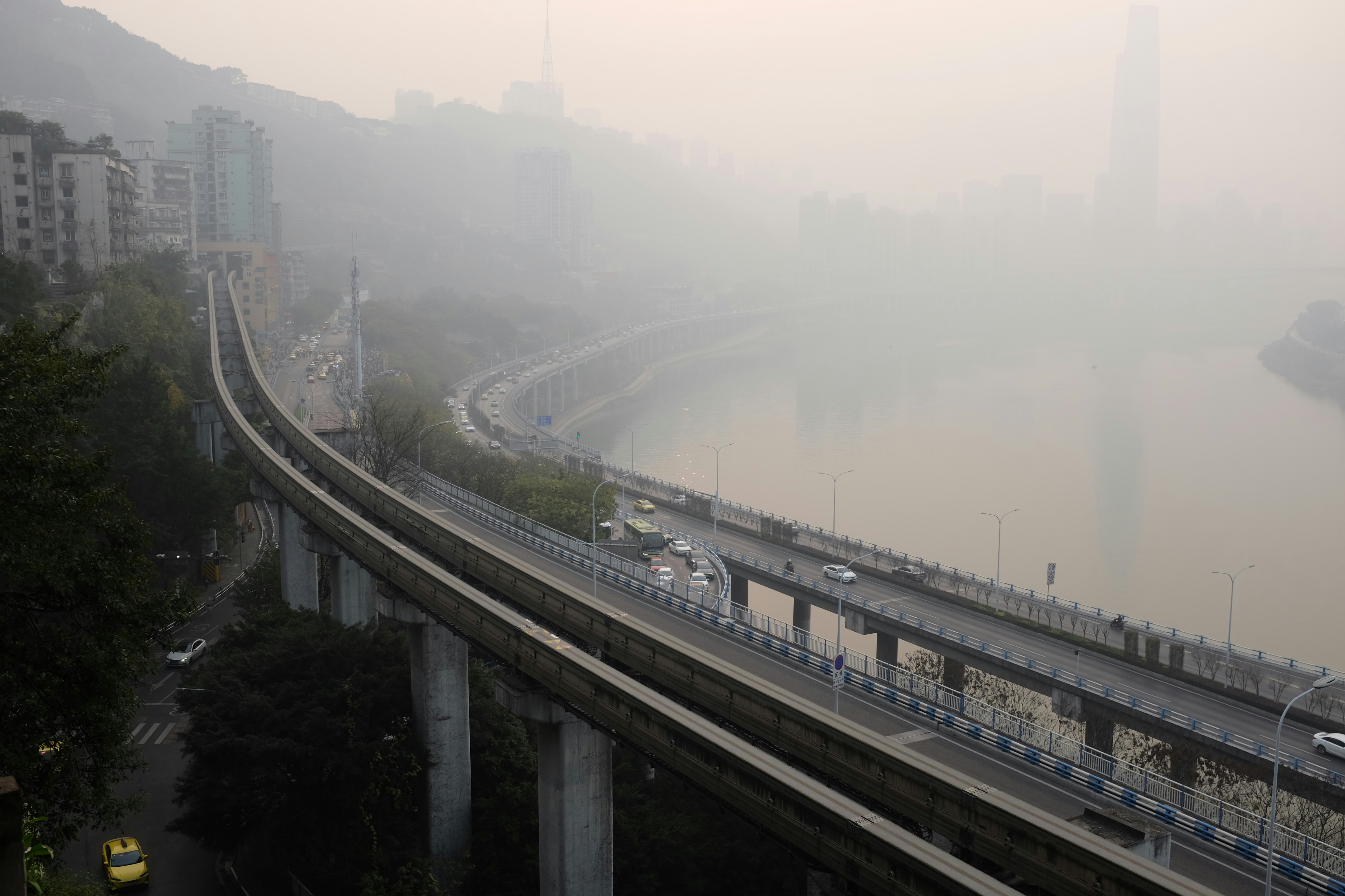 Mist Across the River City: Elevated Highway Ribbon in Fog