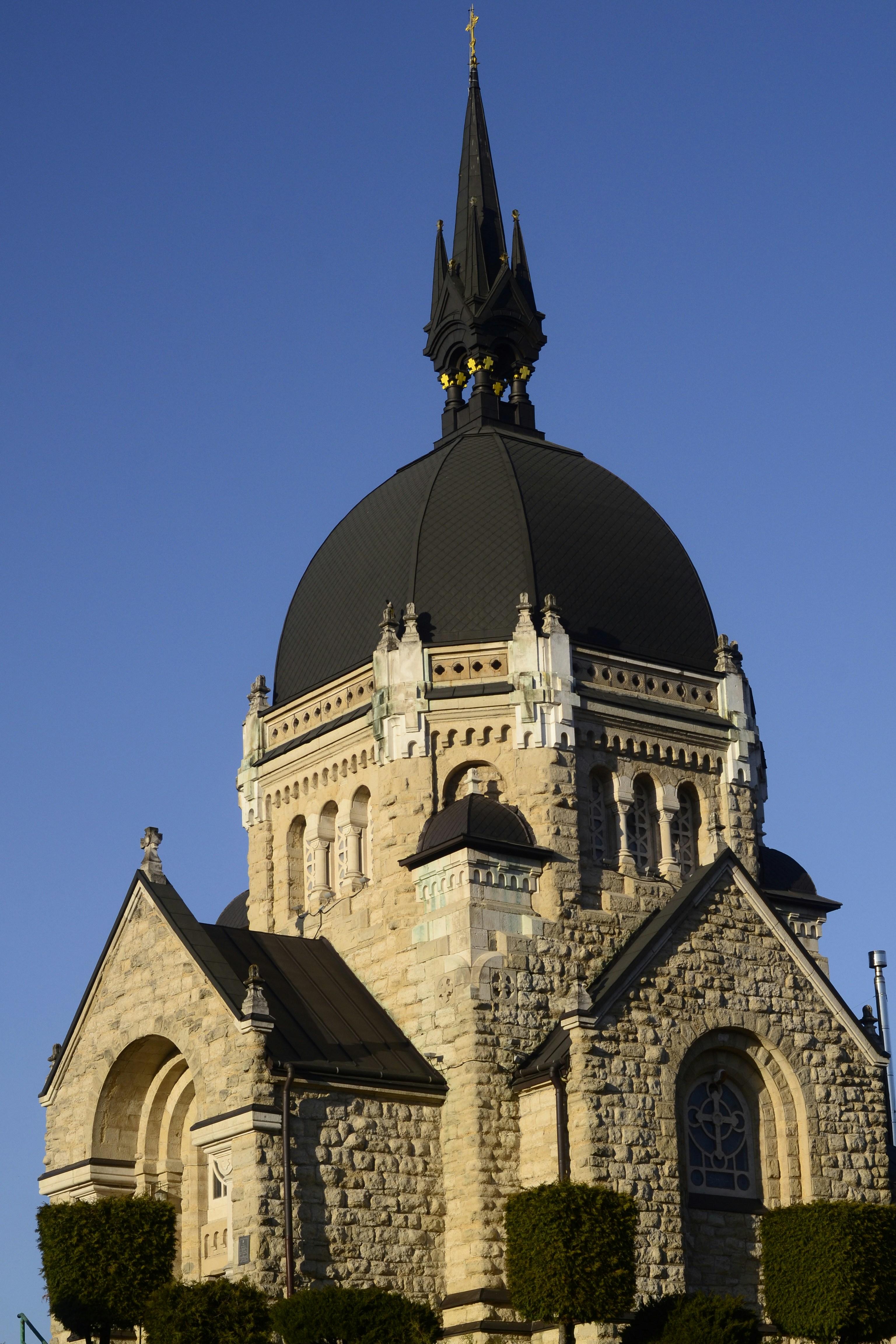 Dome of a Byzantine-inspired church rising against a clear sky