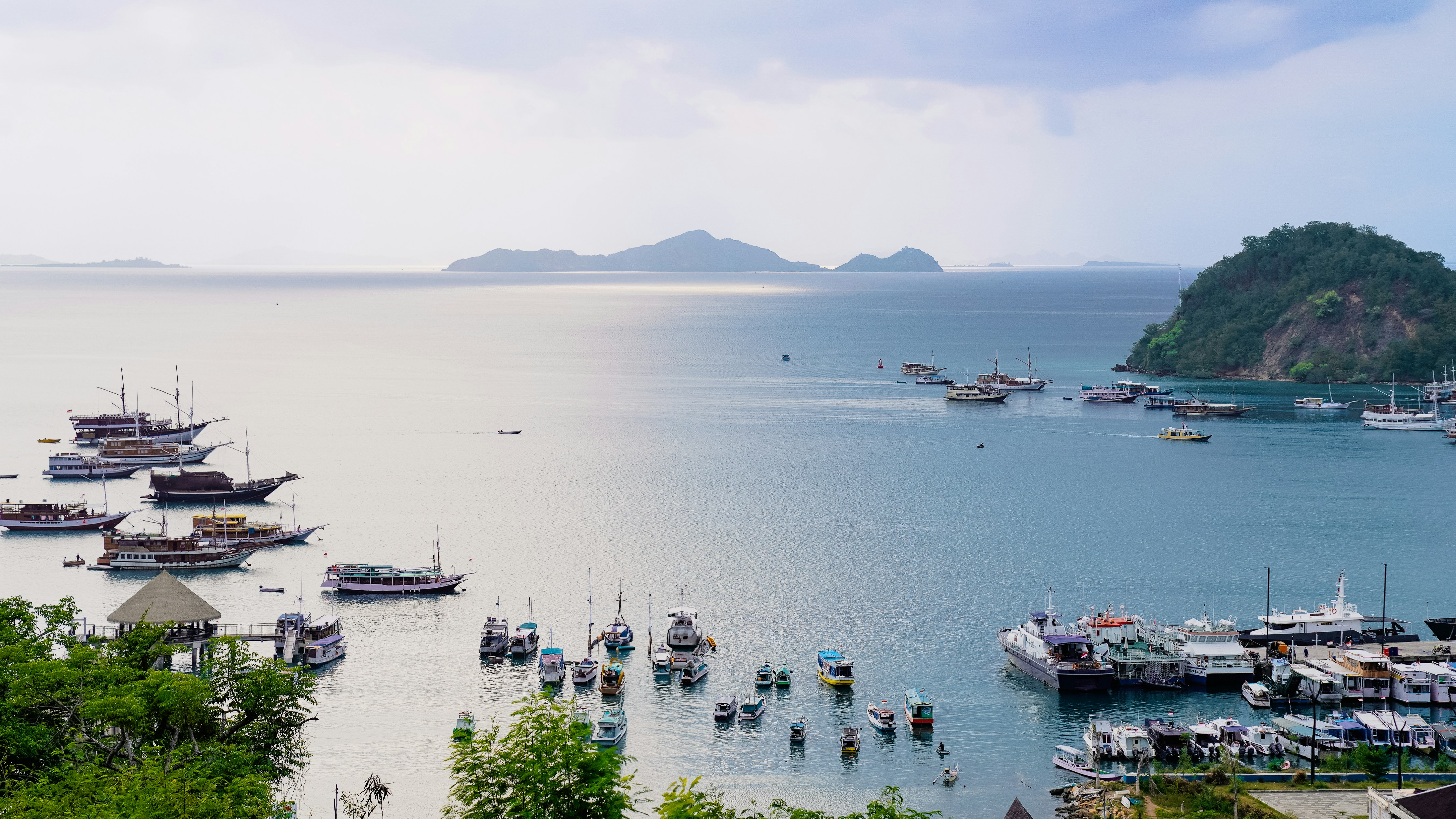 Harbor mosaic: boats, calm water and distant islands