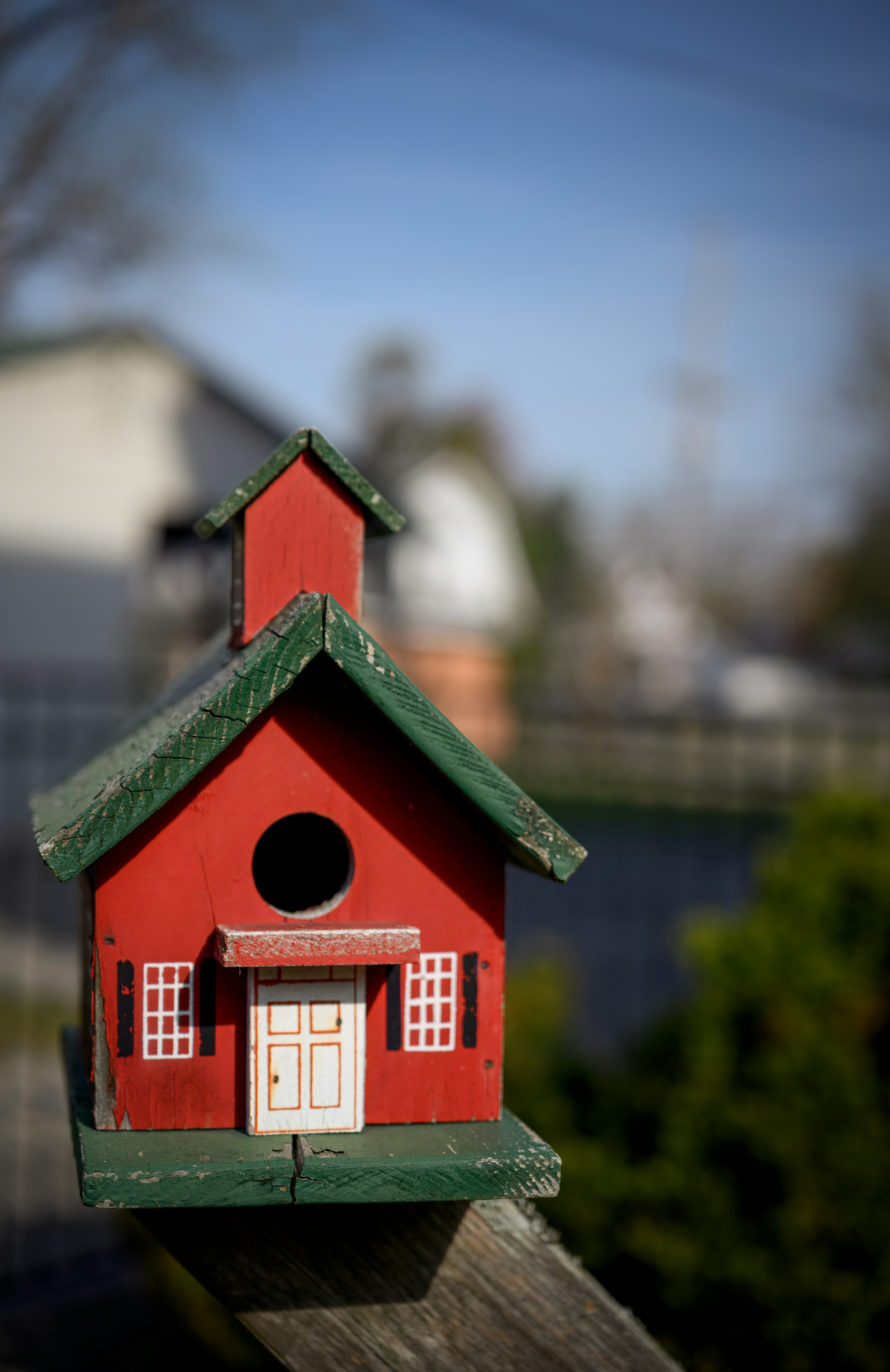 Little Red Birdhouse on a Tilted Fence