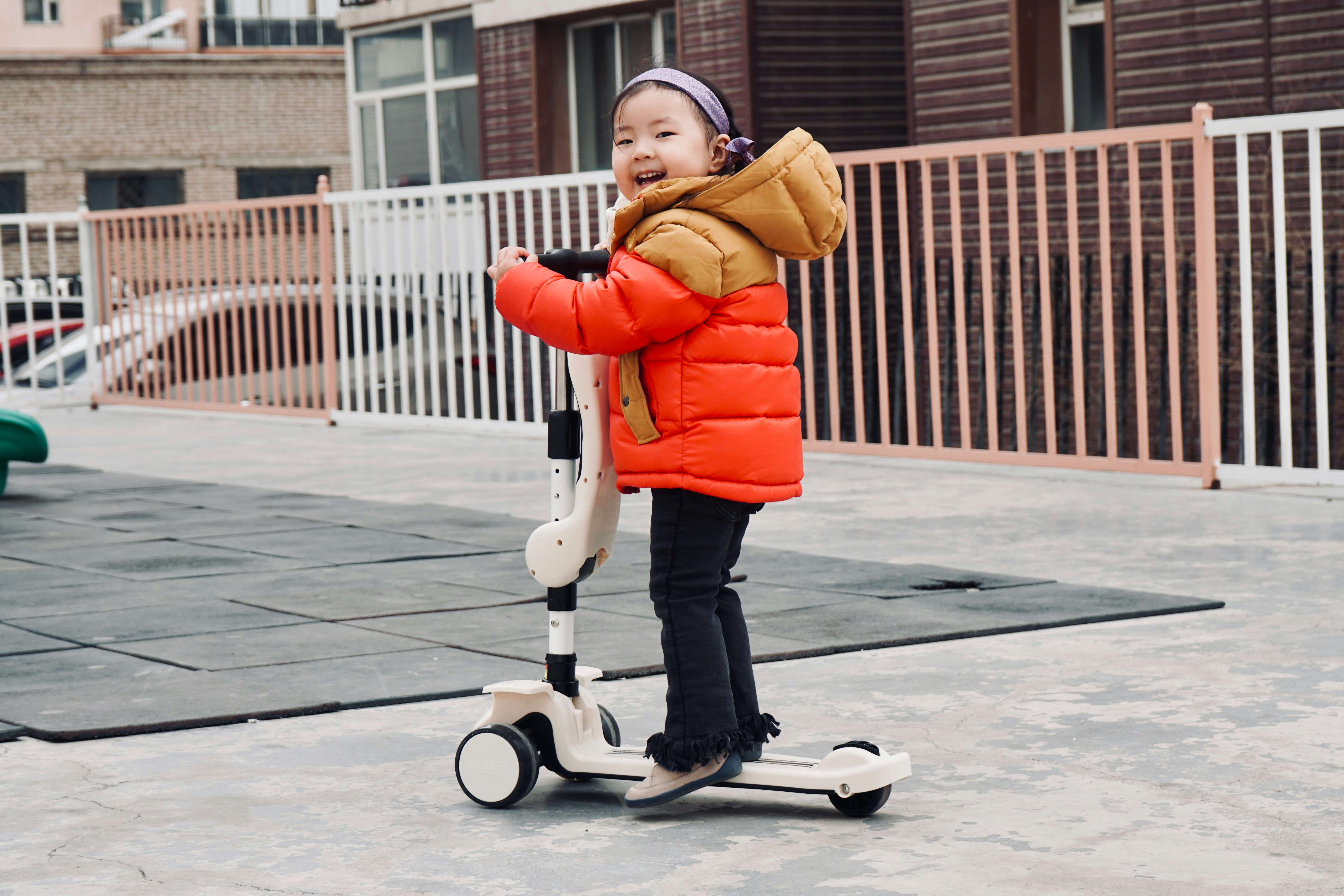 Little Rider: Autumn Coat and Scooter in a Quiet Courtyard