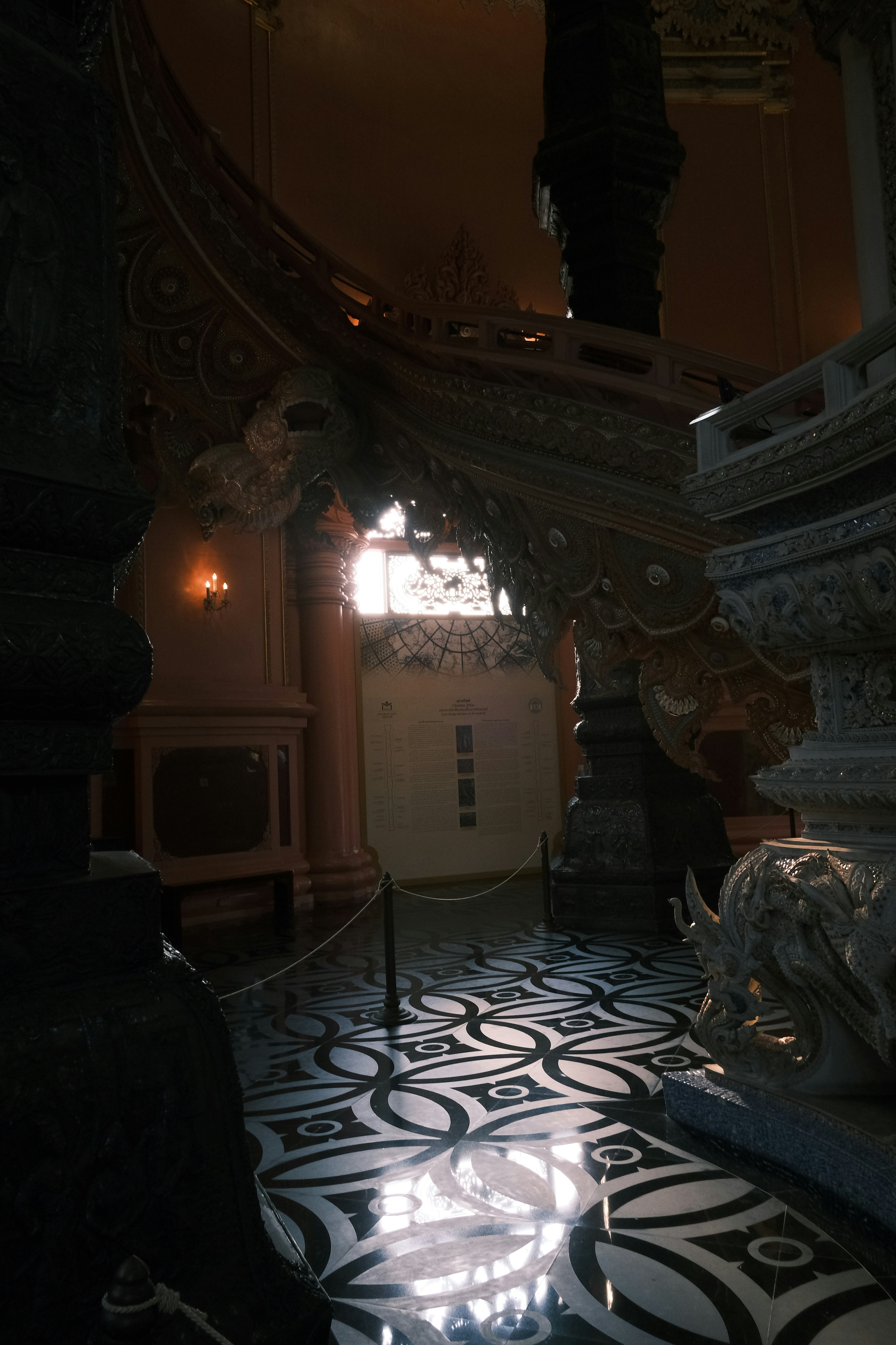 Ornate Interior Under Dim Light: Marble Floor Reflections by a Grand Staircase