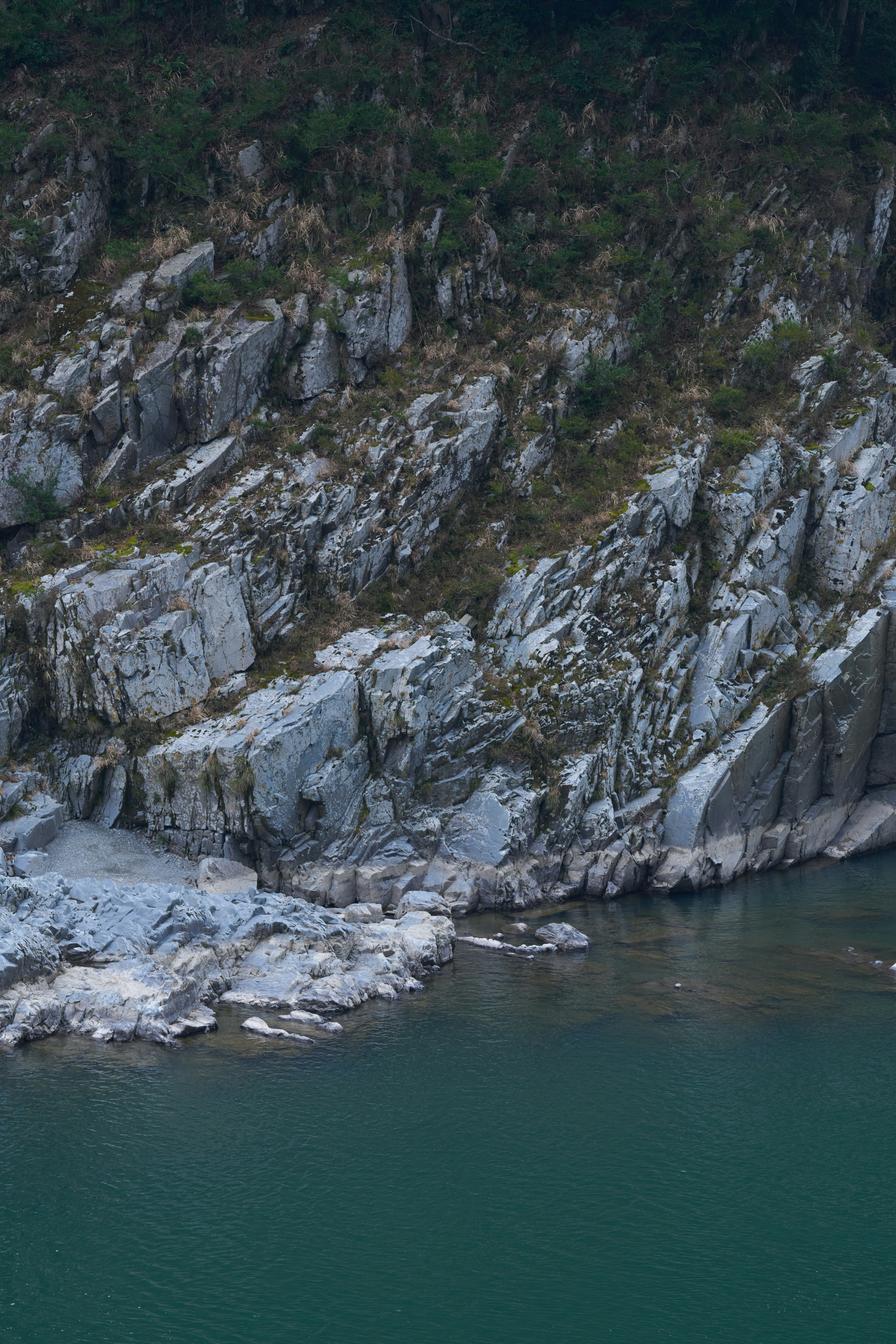 Vertical Cliffscape Meets Emerald Sea