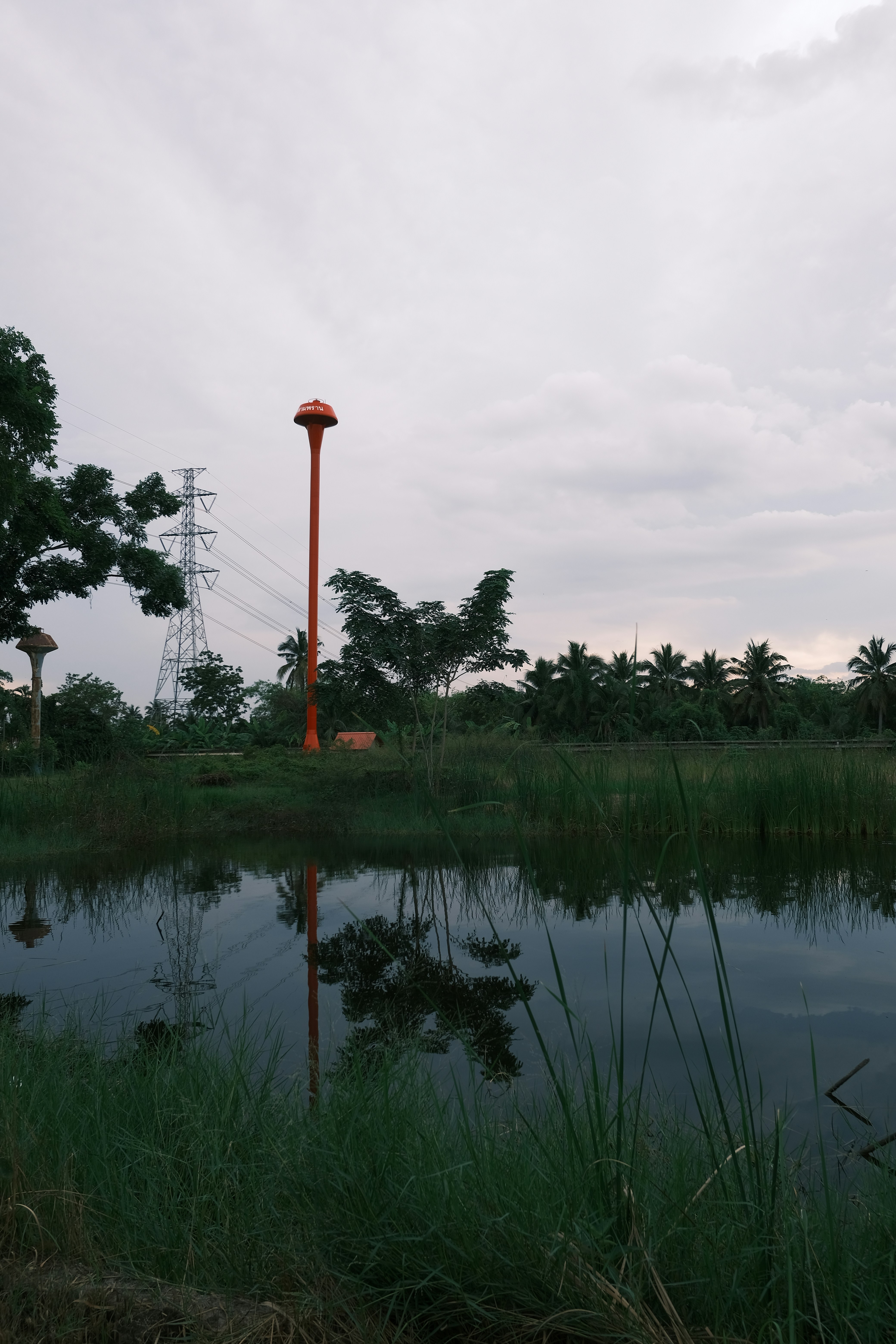 Quiet Water Tower: Reflections Under an Overcast Sky