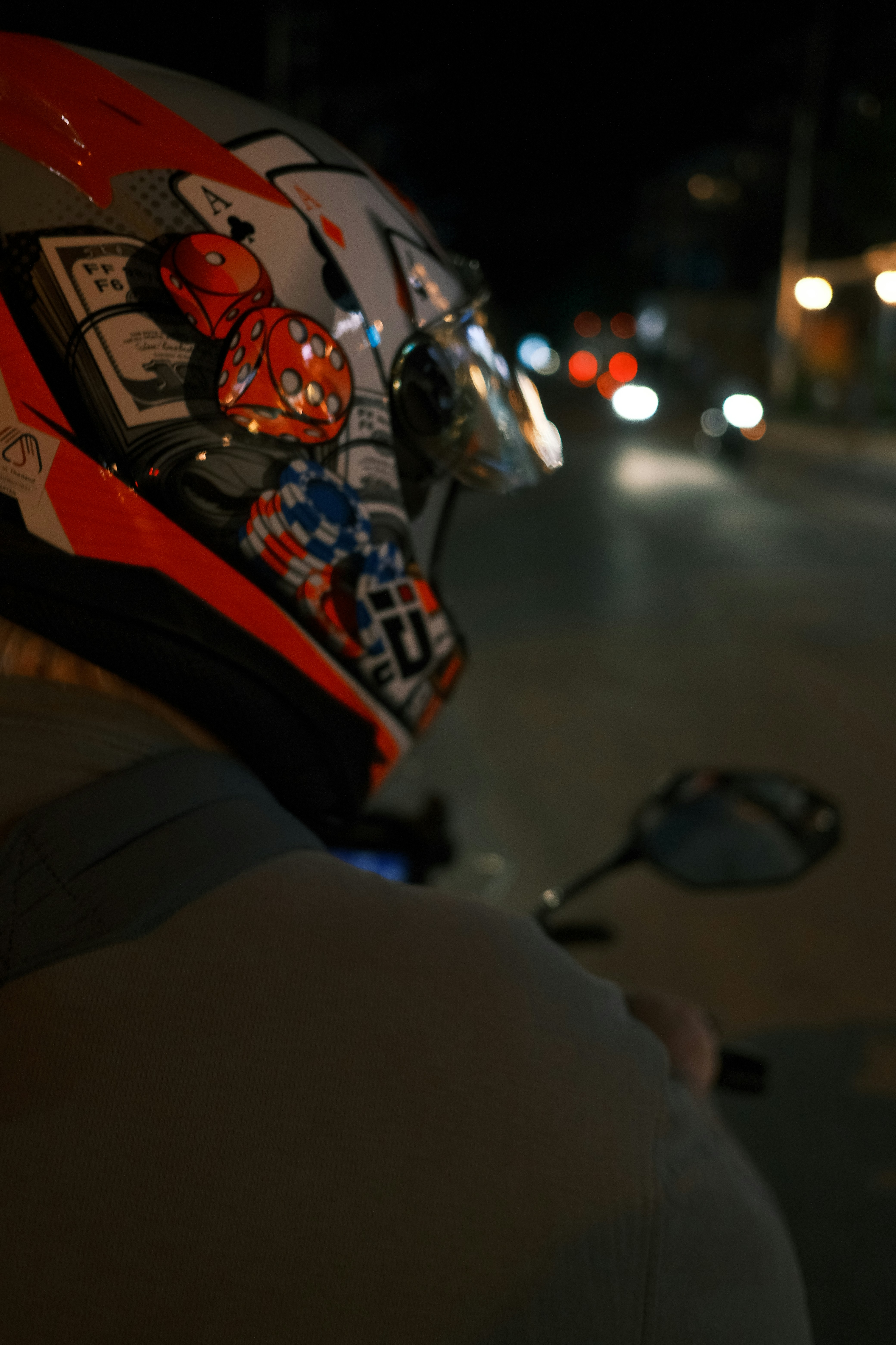Neon Night Rider: A Helmet Adorned with Poker Cards and Dice