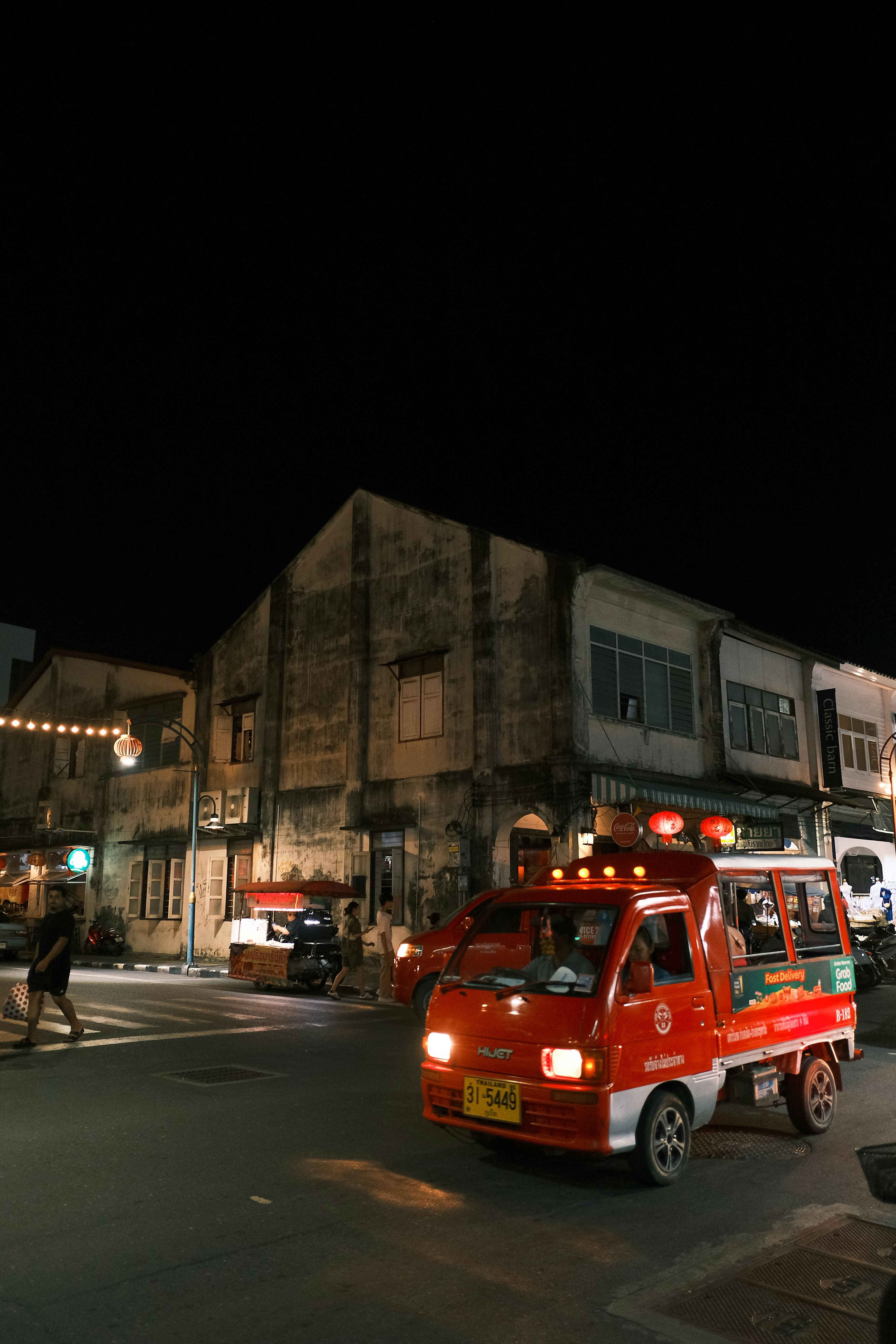Red Commuter at Night: Street Corner with Weathered Facade