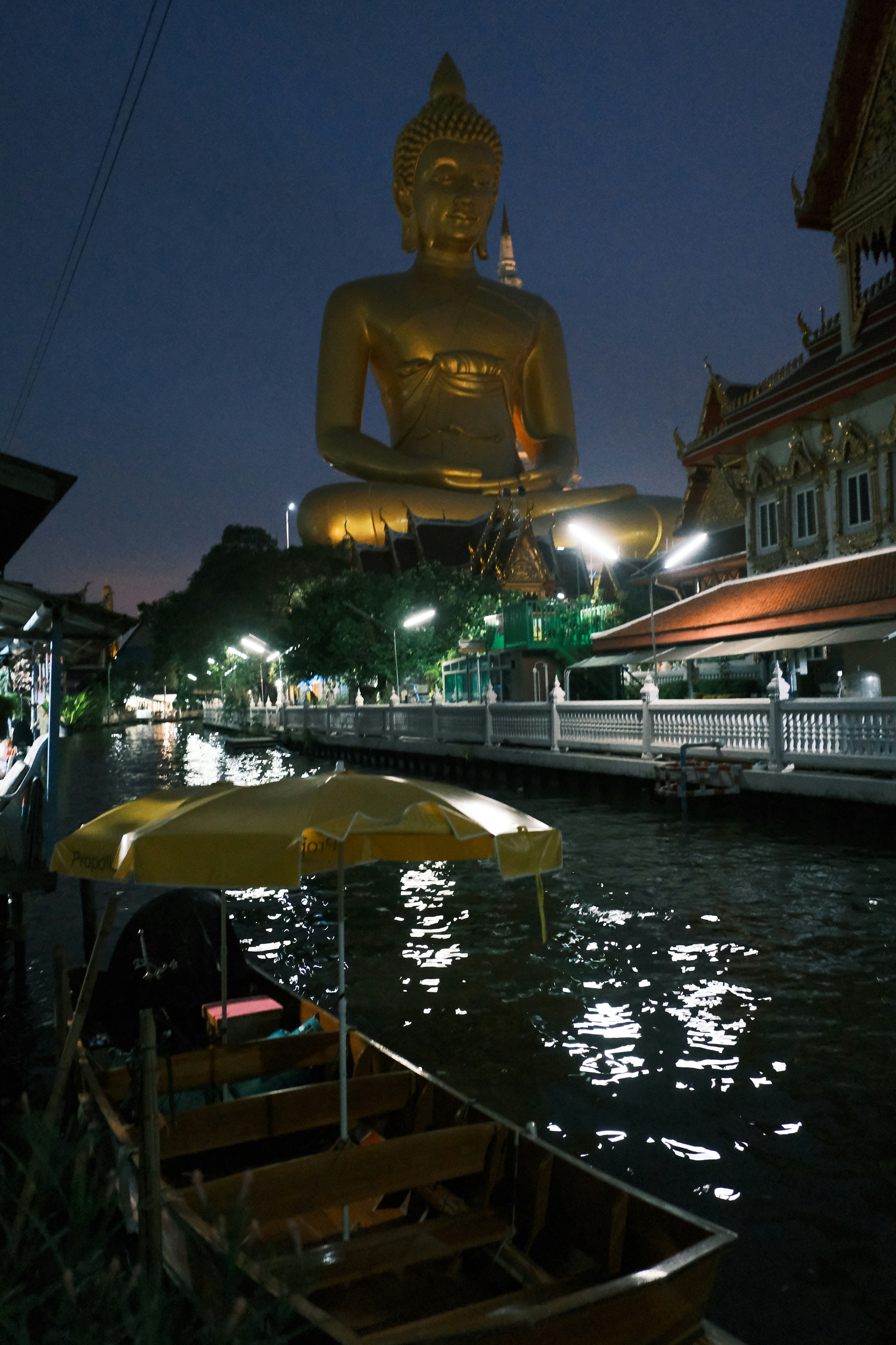 Golden Giant by the Canal at Dusk