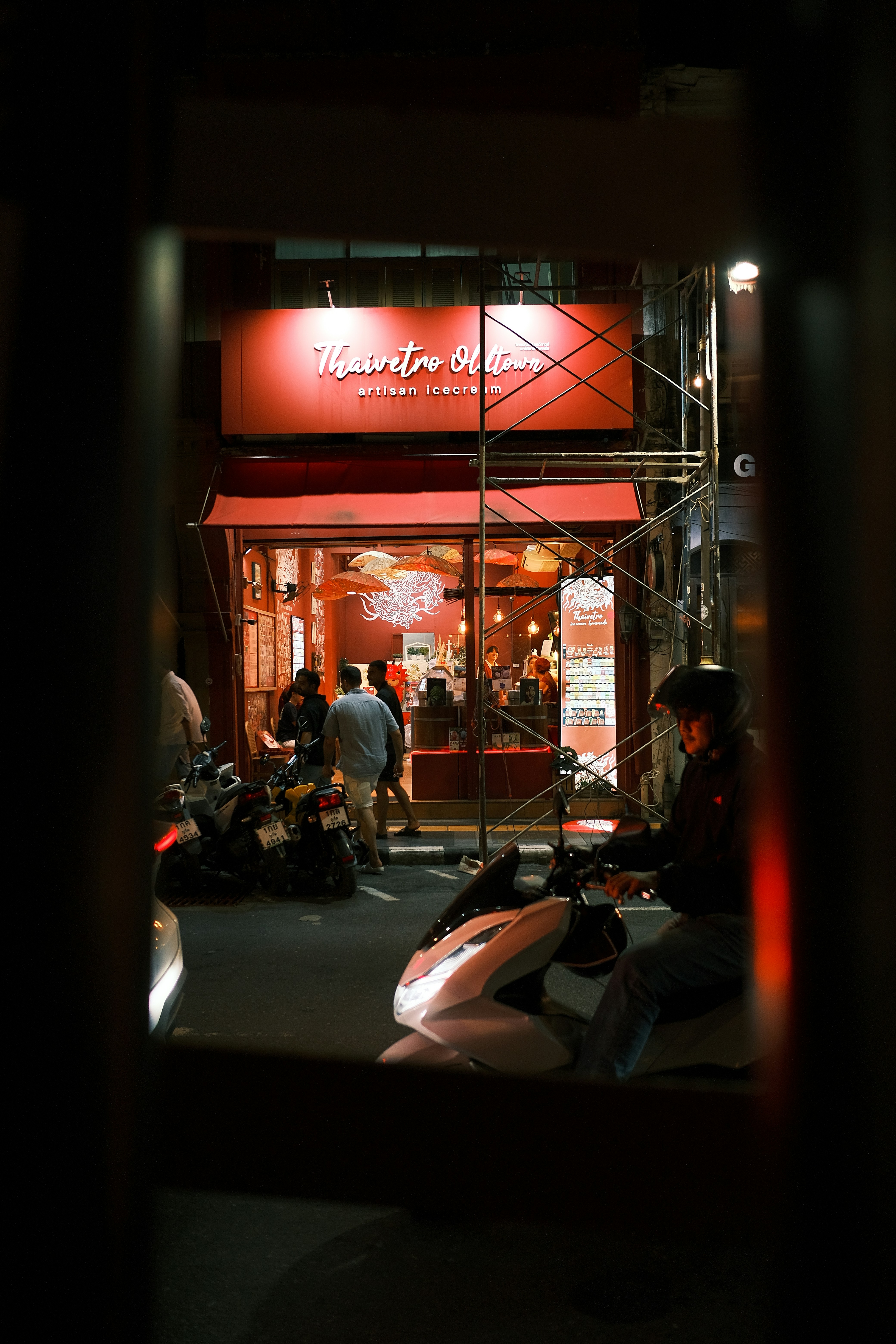 Neon Red Threshold: Evening Convergence at a Busy Streetfront