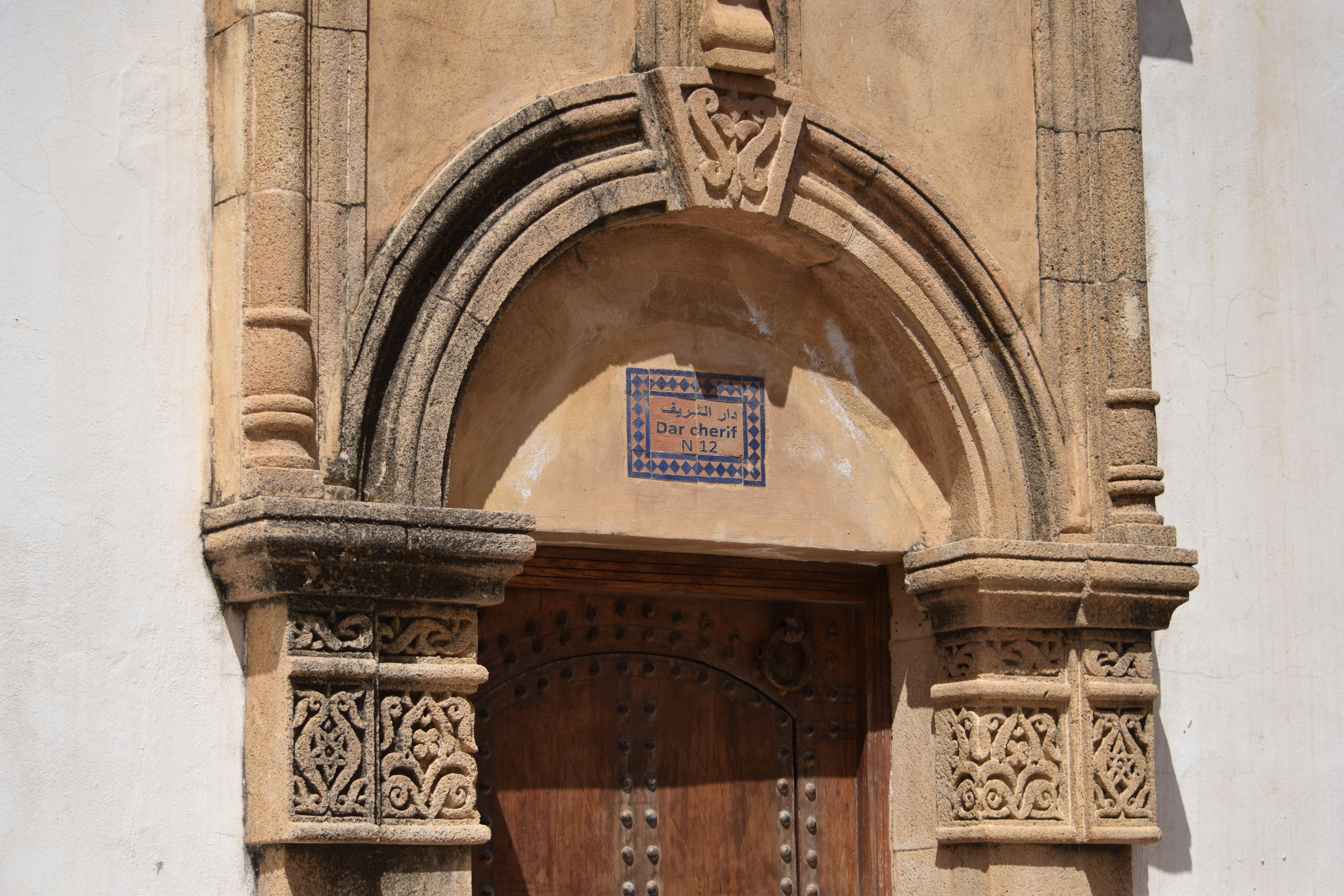 Stone Archway Crowned Doorway with Ornate Carvings