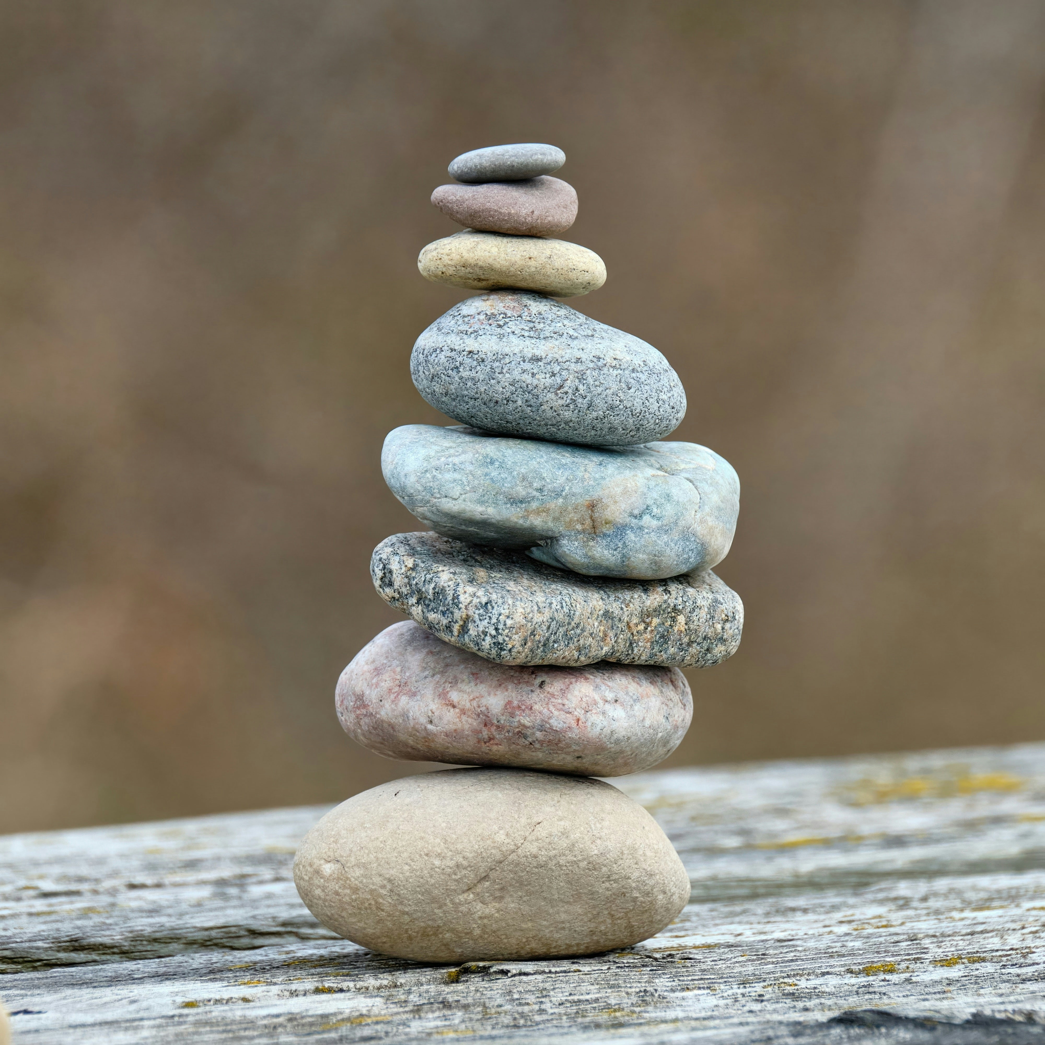 Balanced Pebble Tower on Weathered Wood