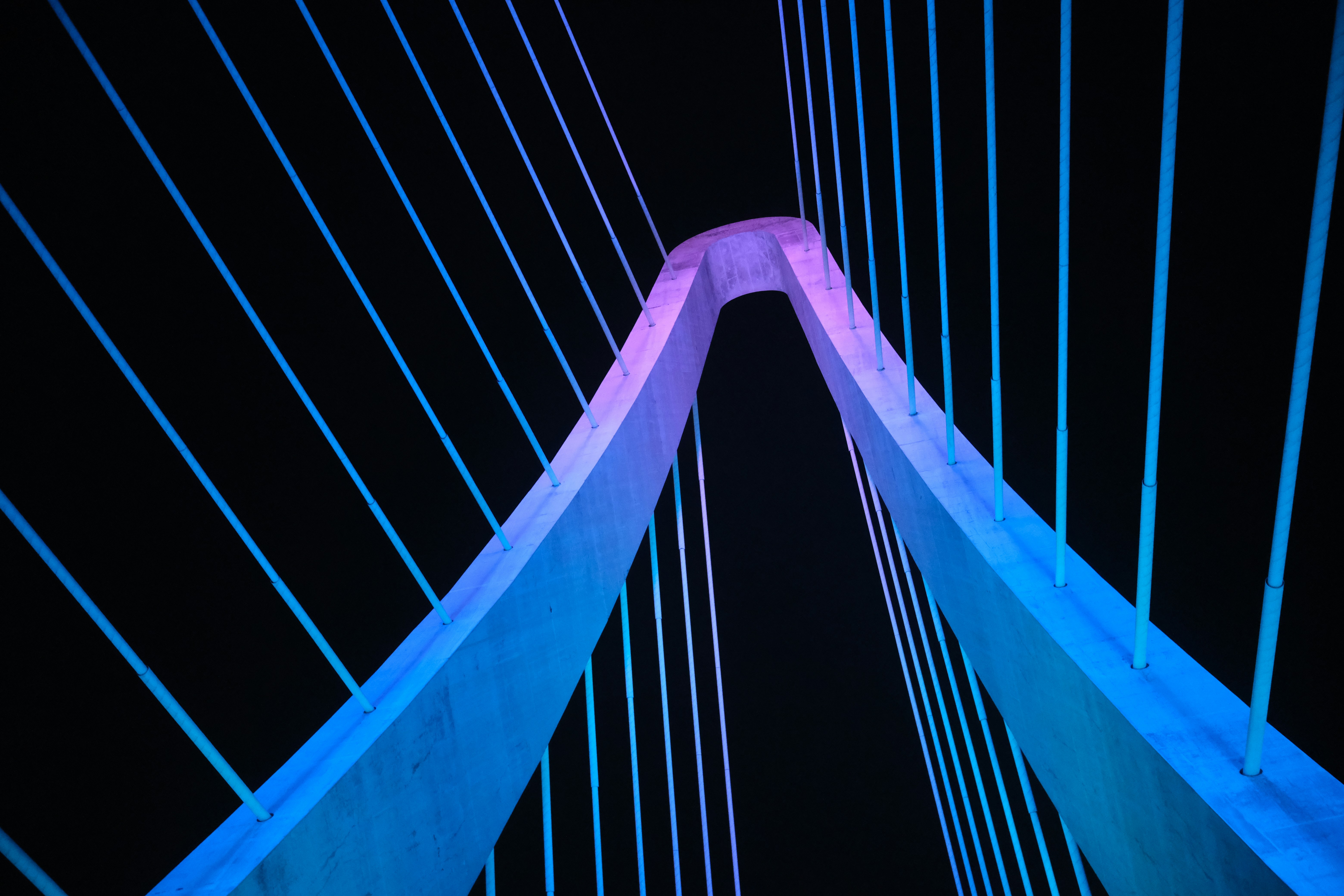 Neon-Outlined Cable Arch: Night Beyond the Bridge