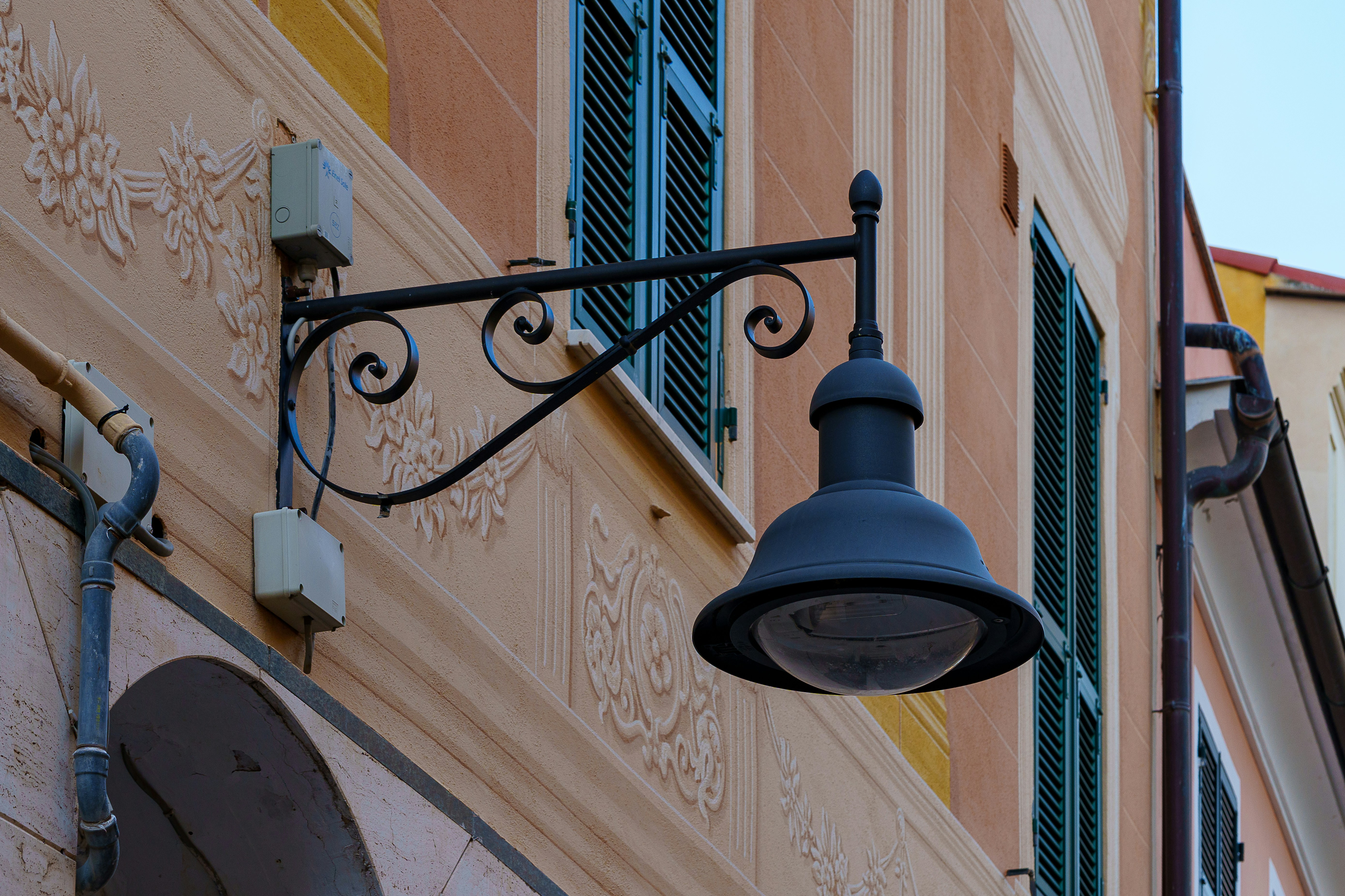 Ornate Street Lamp Framing a Sunlit Facade