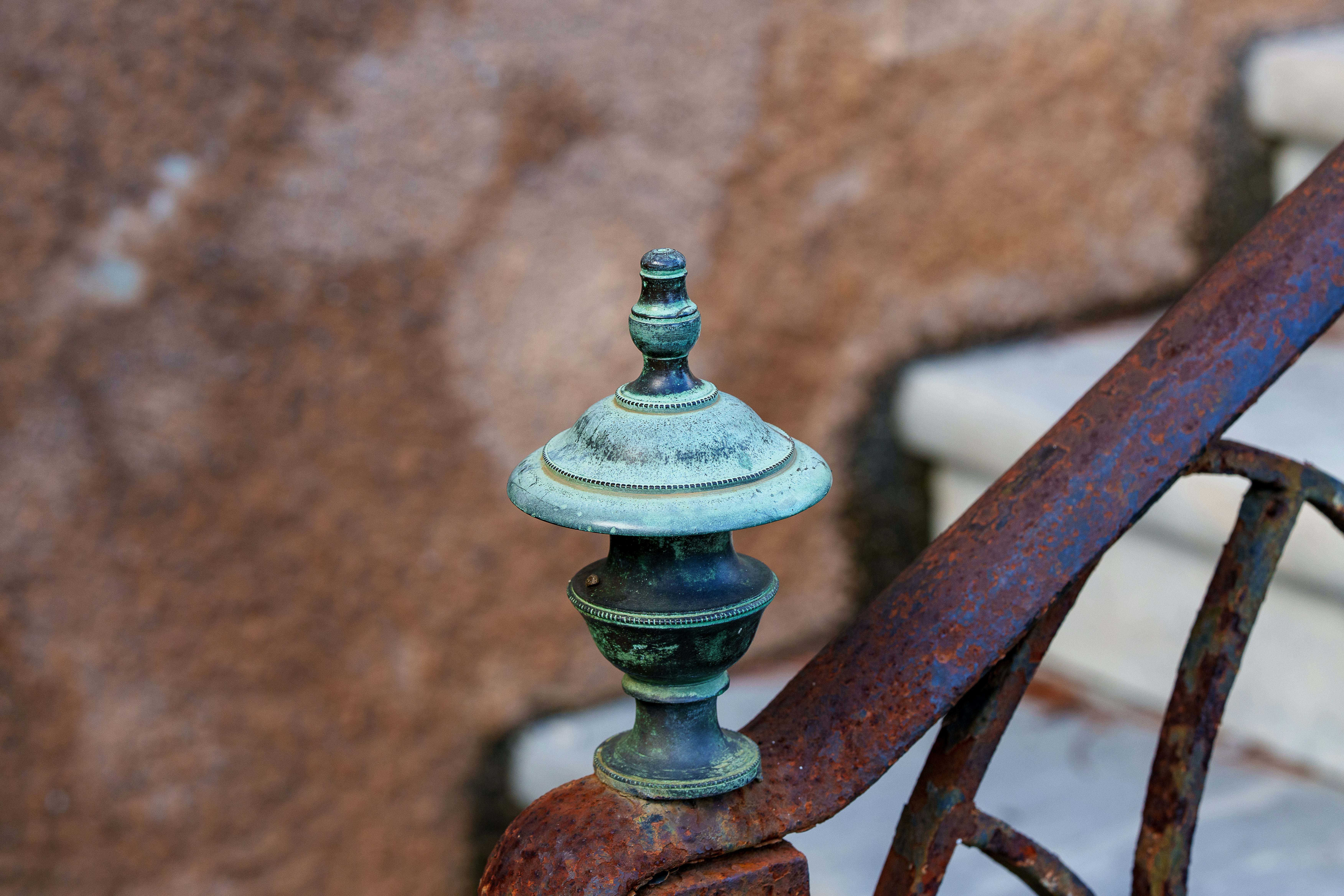 Weathered Finial on a Rusted Railing: Quiet Echo of a Forgotten Porch