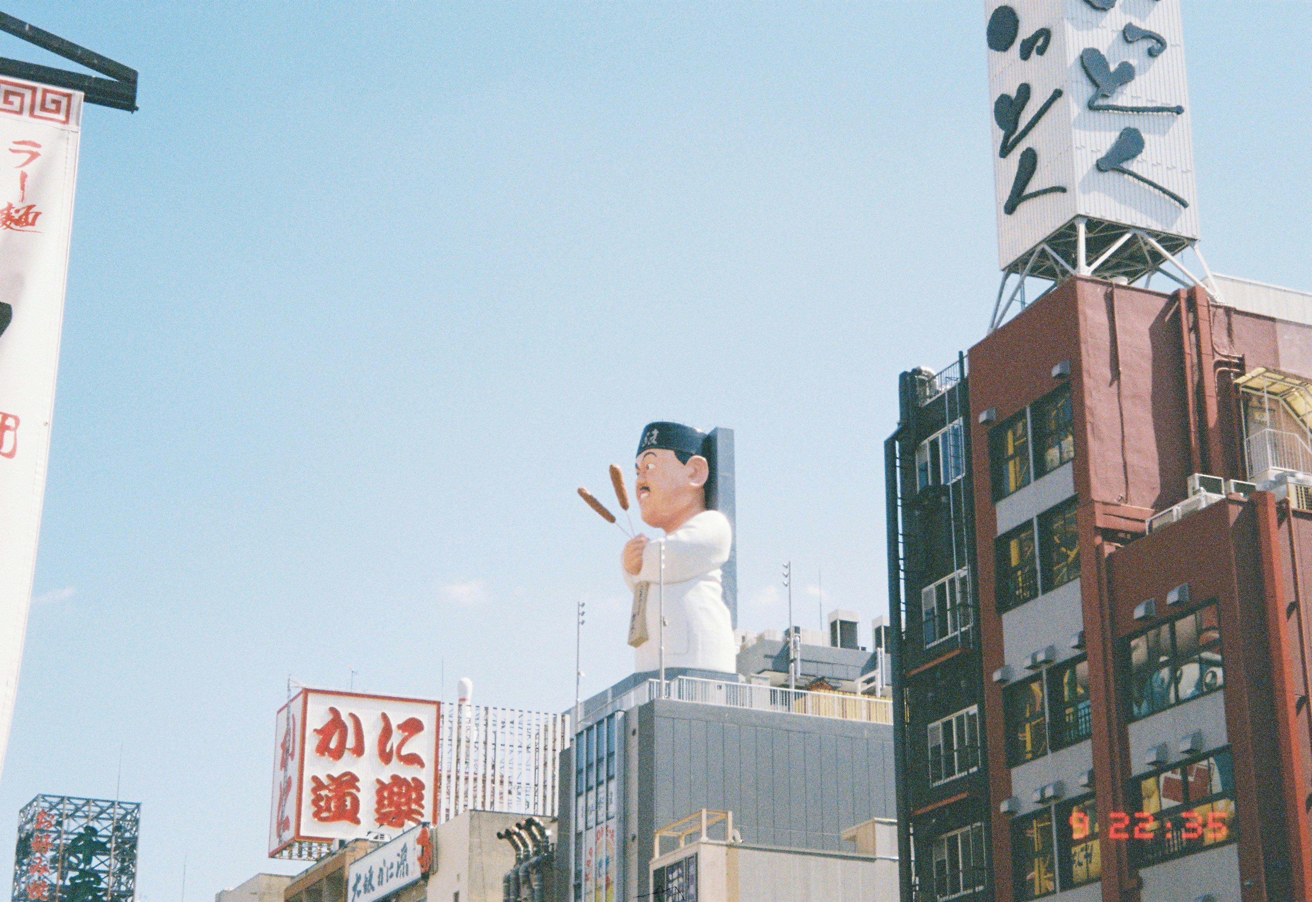 Harbor of Giant Lanterns: Street Portrait Beneath Neon and Sky