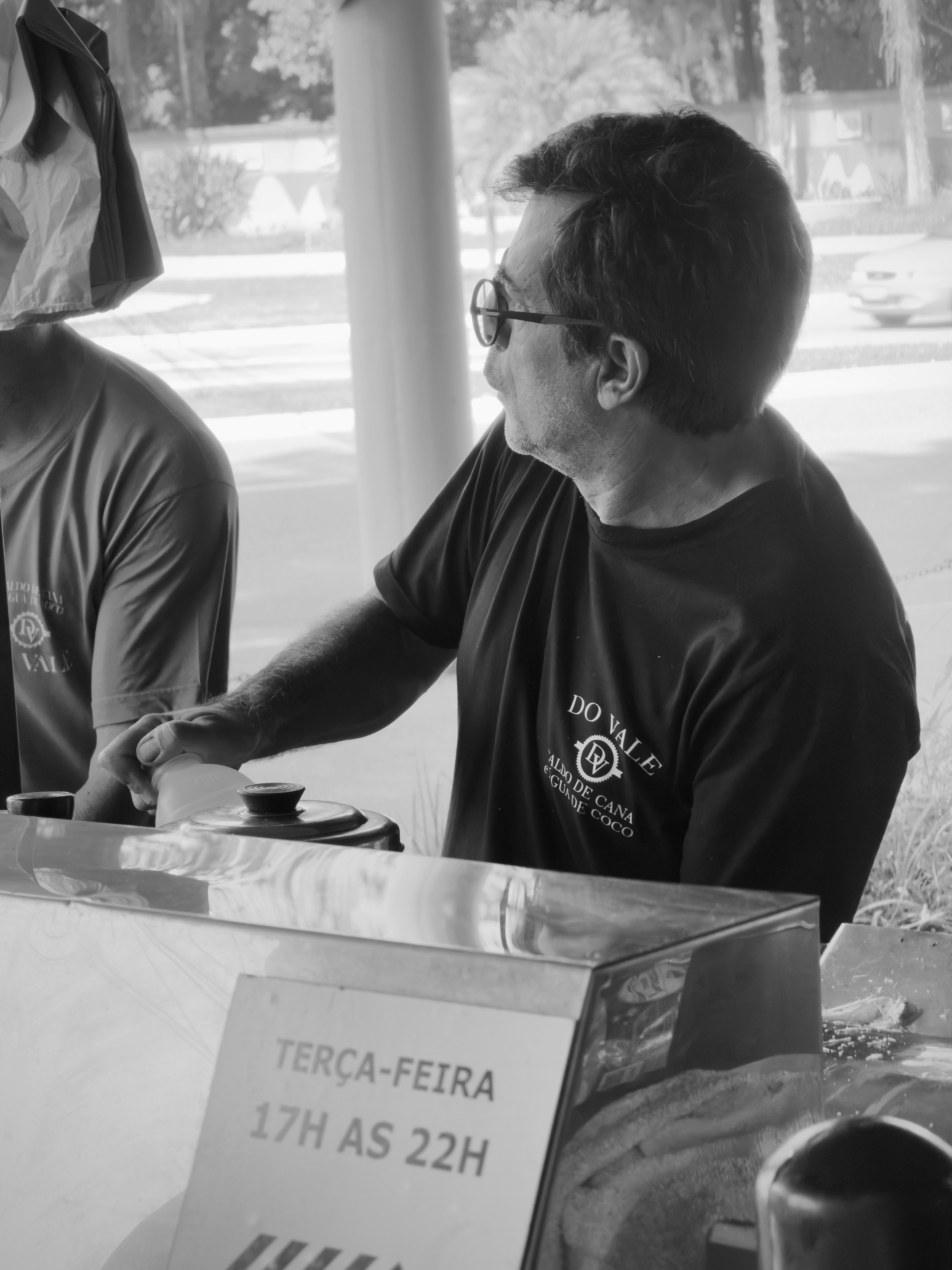 Portrait at the Counter: A Volunteer in Shade and Light