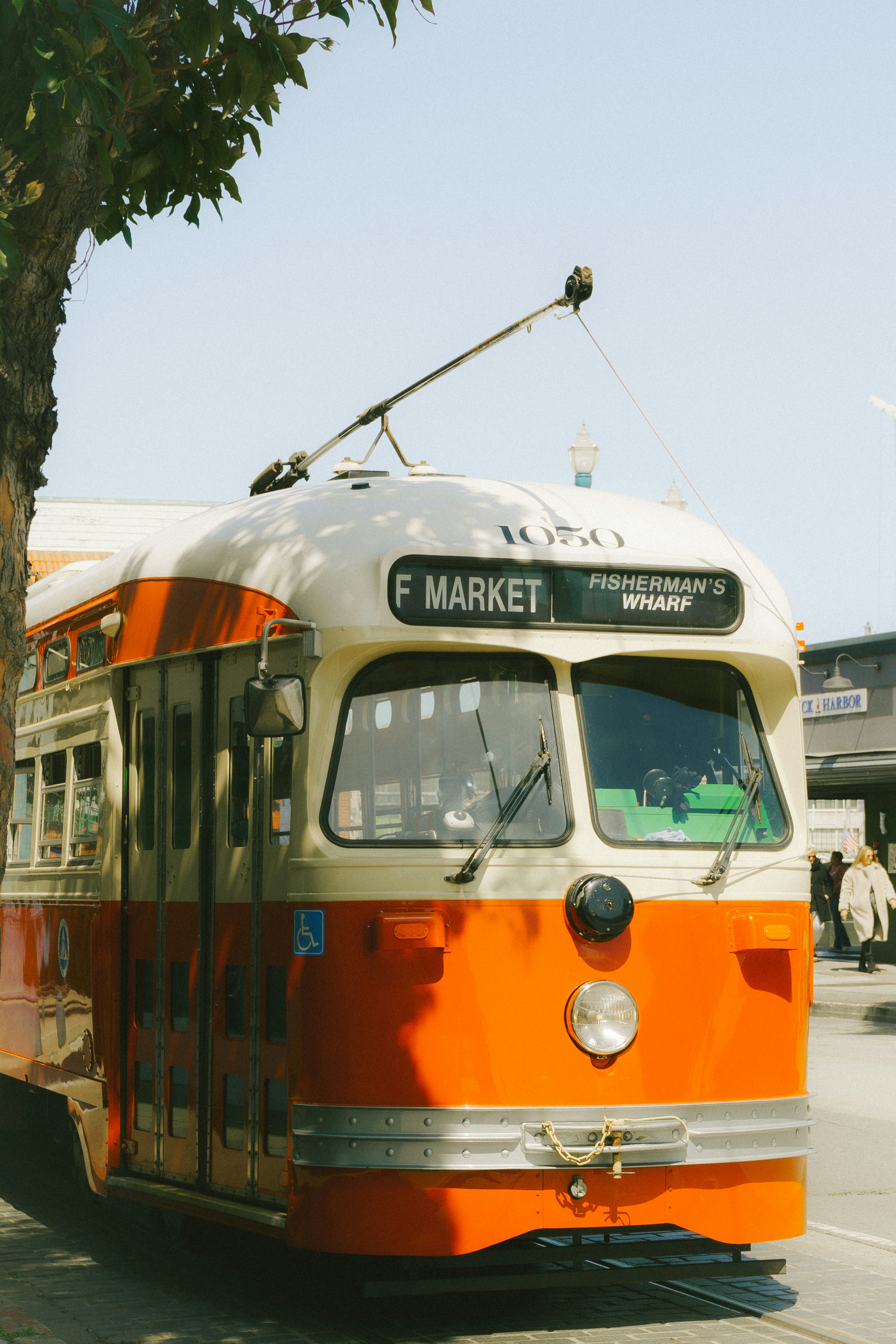 Orange Streetcar at Fisherman's Wharf: A Retro Glide through Shoreline Light
