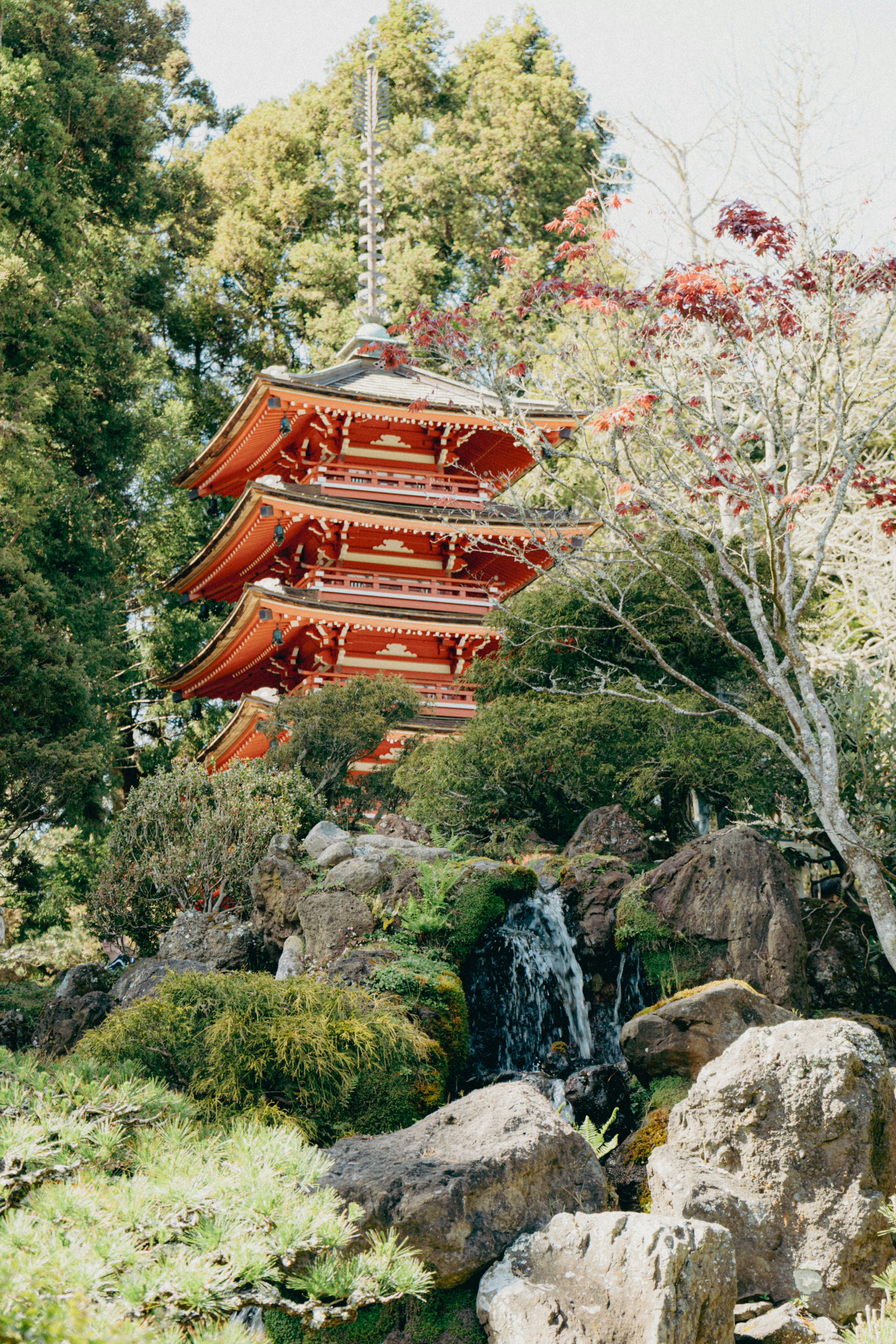 Crimson Pagoda Amid Stones and Waterfalls