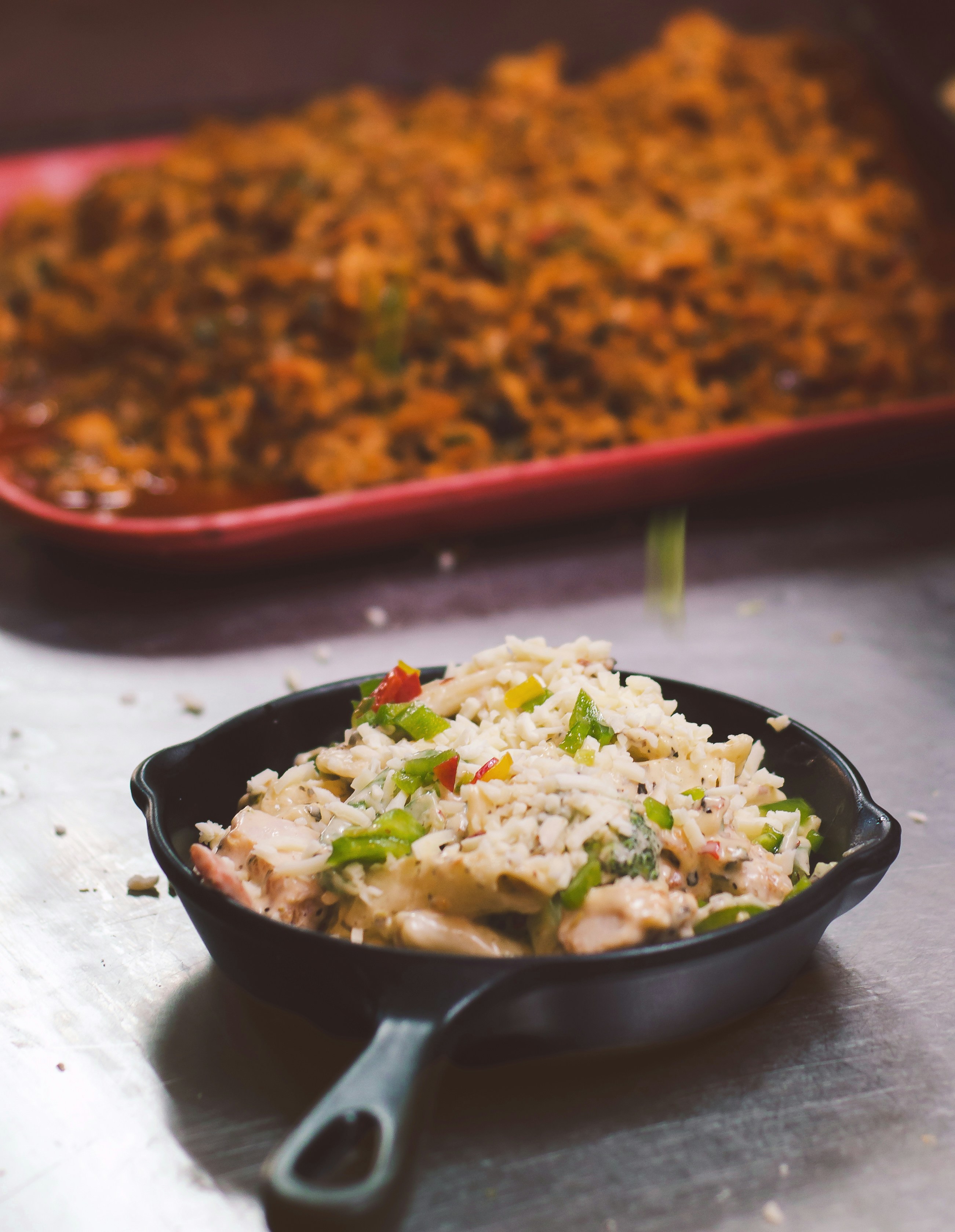 Sizzling skillet of chicken and peppers in a bubbling kitchen scene