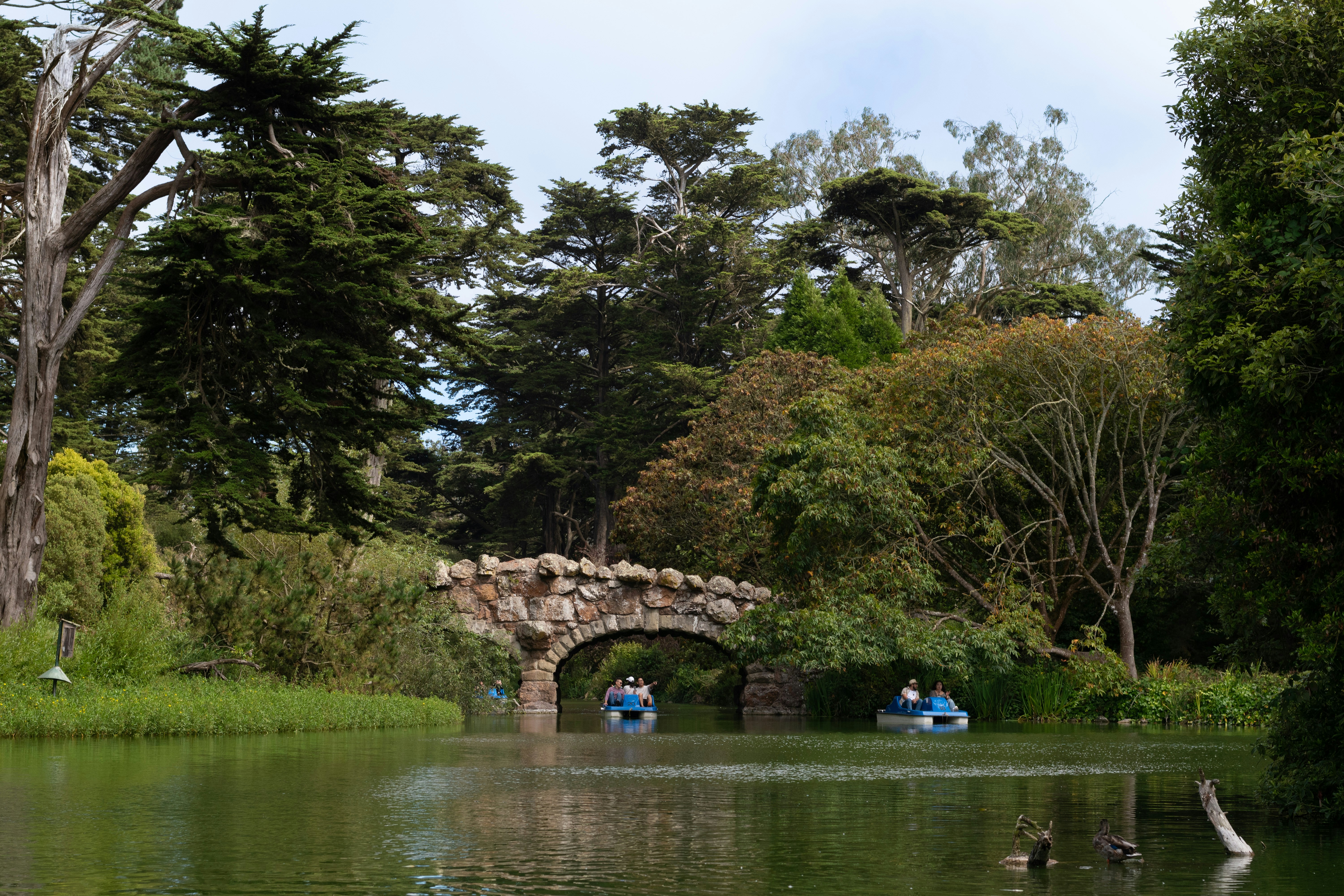 Stone Archway Over Calm Water in a Serene Park