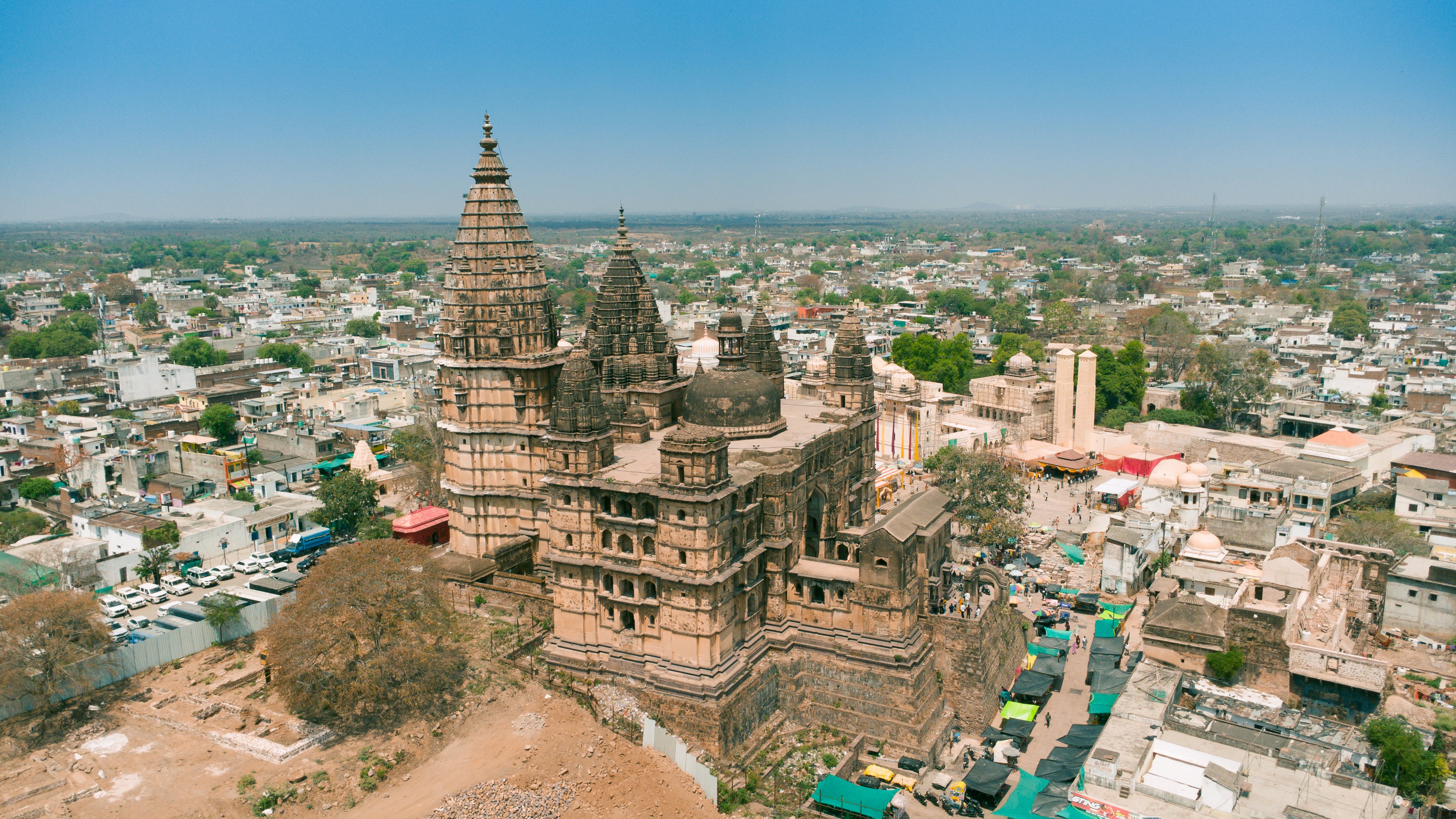 Sunlit Vishnupuram Temple Rising Over an Aerial Cityscape