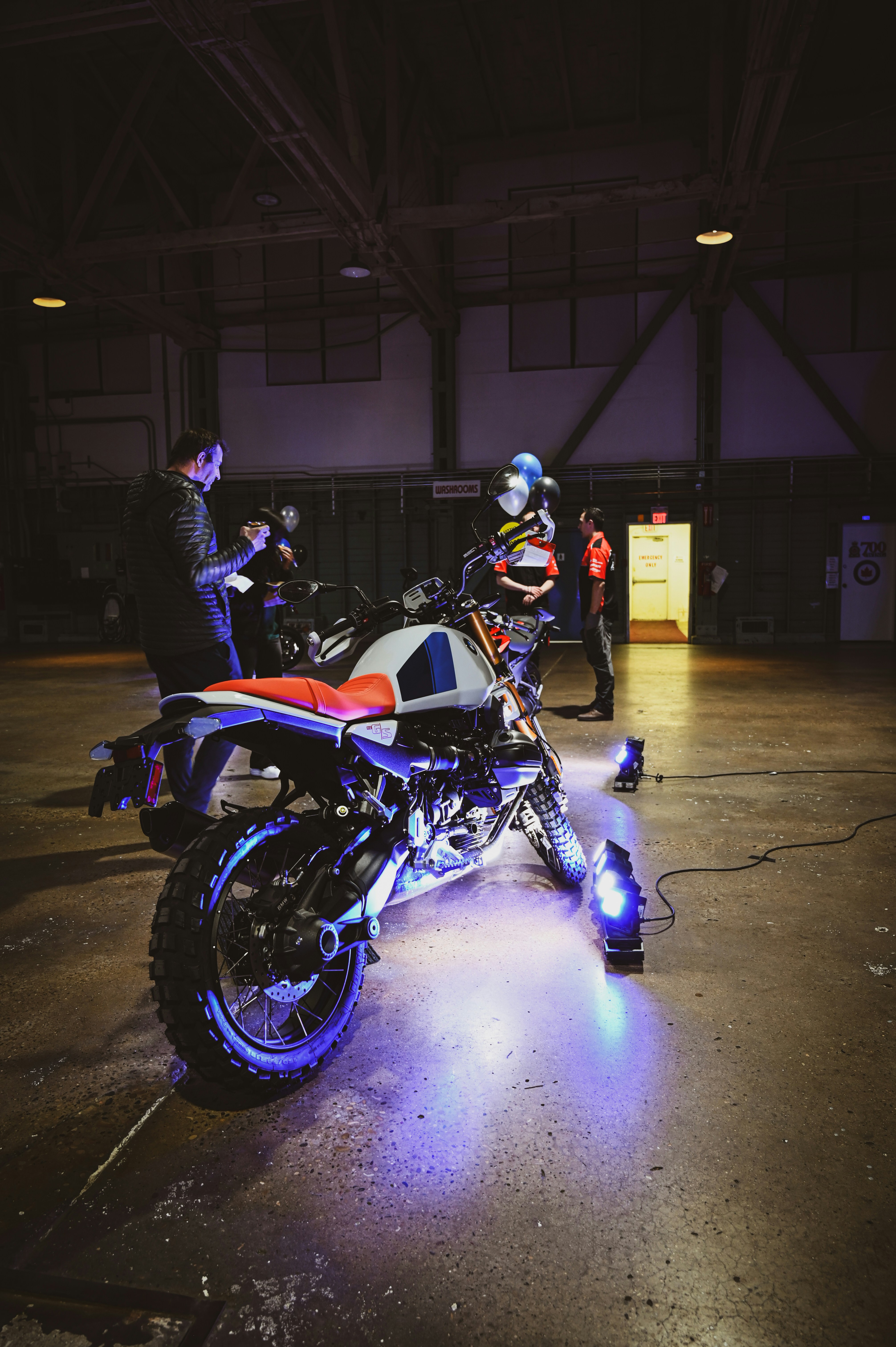 Showroom Night: Neon-lit Adventure Bike on Stage