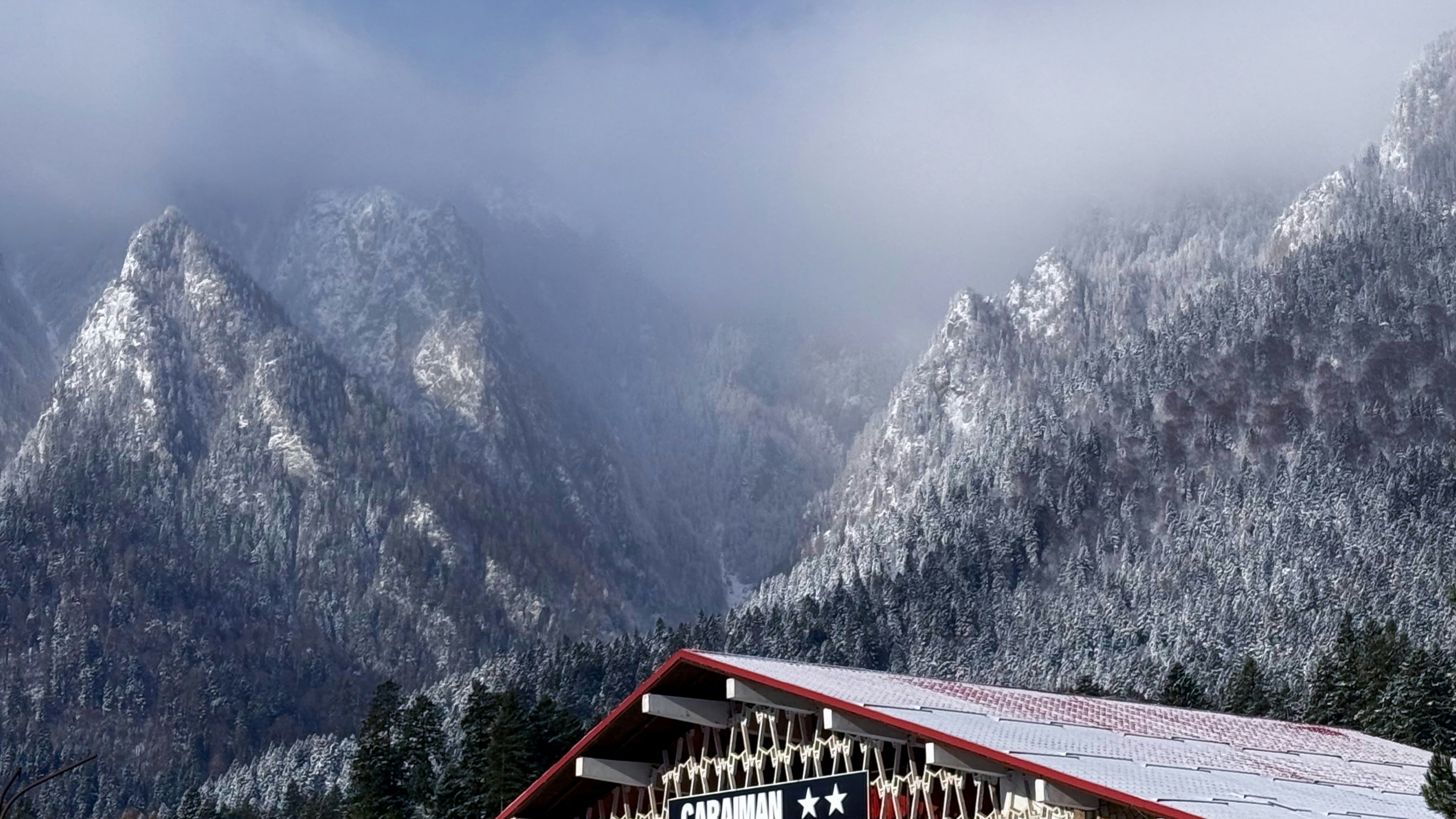 Snowbound Peaks Over a Rustic Red-roofed Chalet