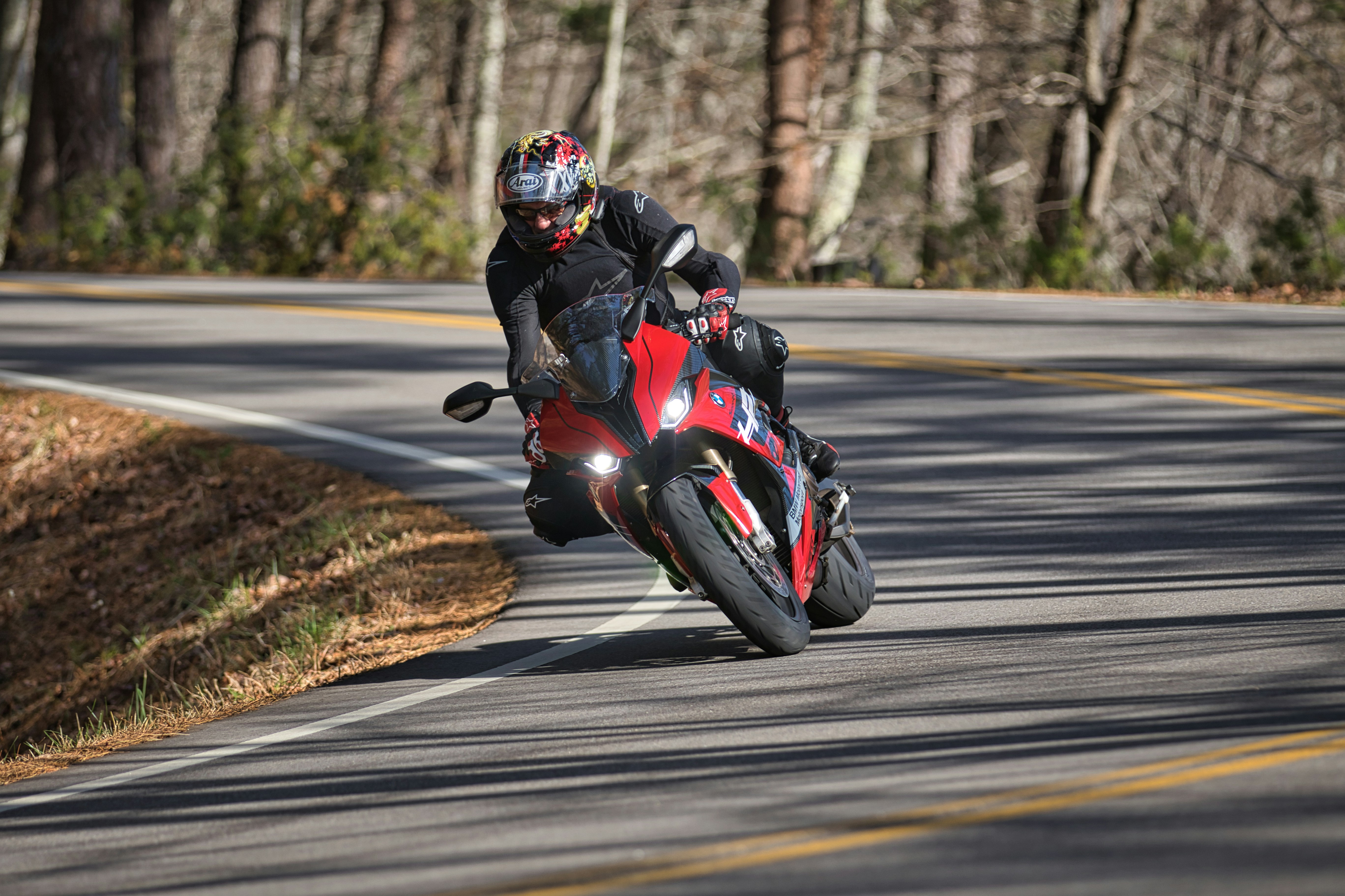 Red-Streaked Rider: A Lean Turn Through Autumn Shade