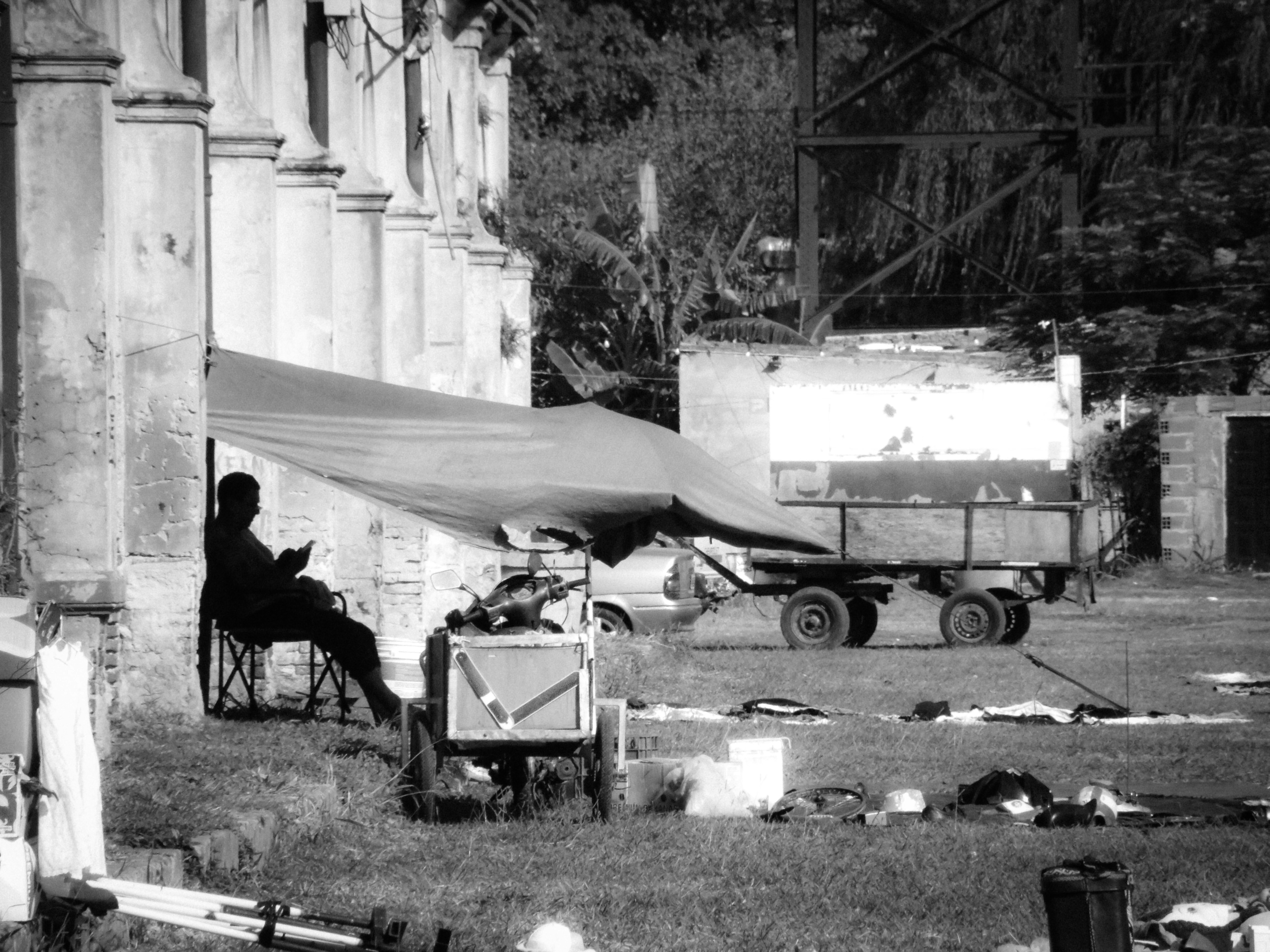 Shaded street-side rest under an old building
