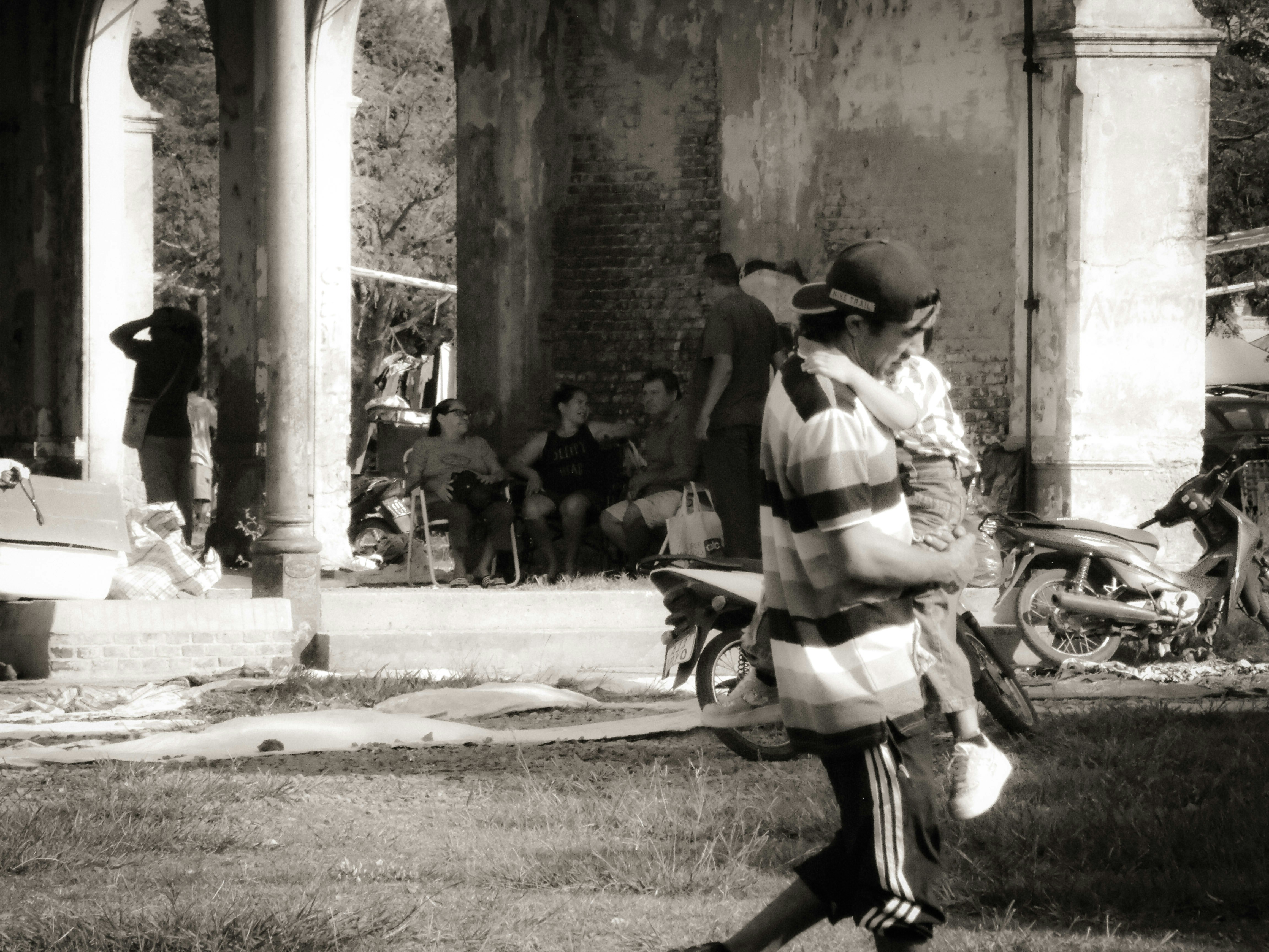 Striding Through the Colonnade: A Moment in Shade