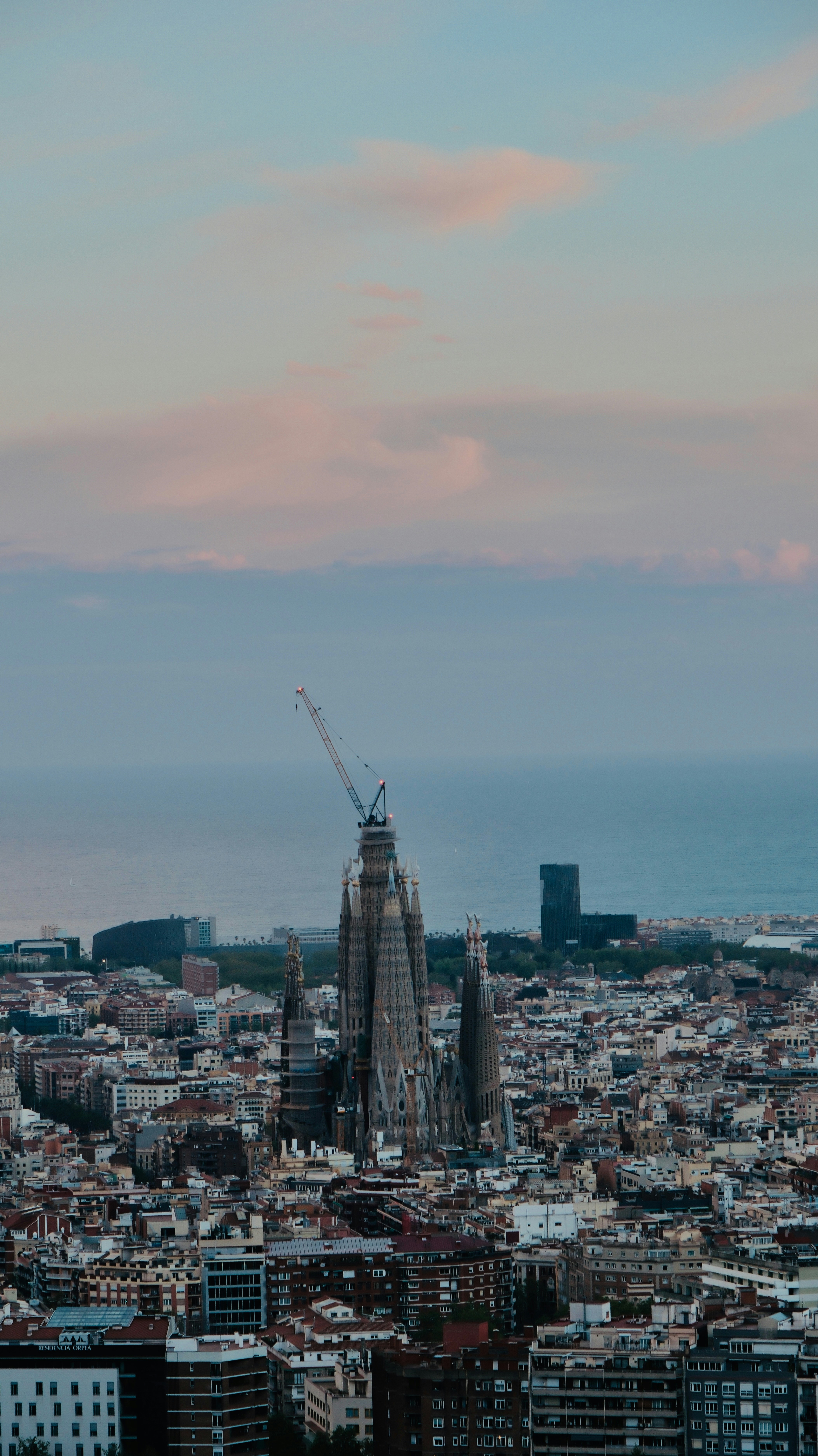Crane Crown over Barcelona: Sagrada Família Surrounded by a Sea of Rooftops