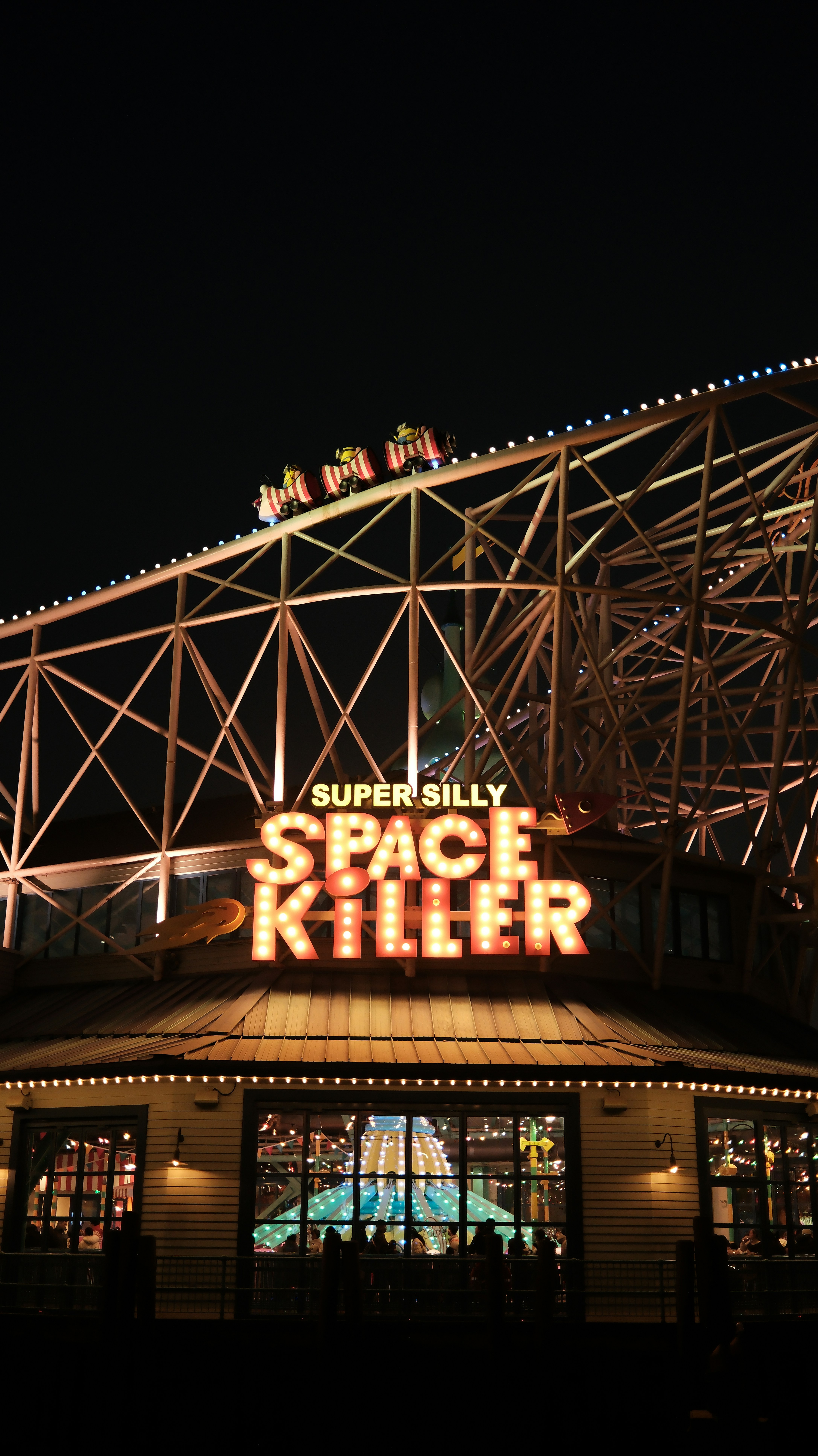 Illuminated Signage at Night: Space Killer Ride
