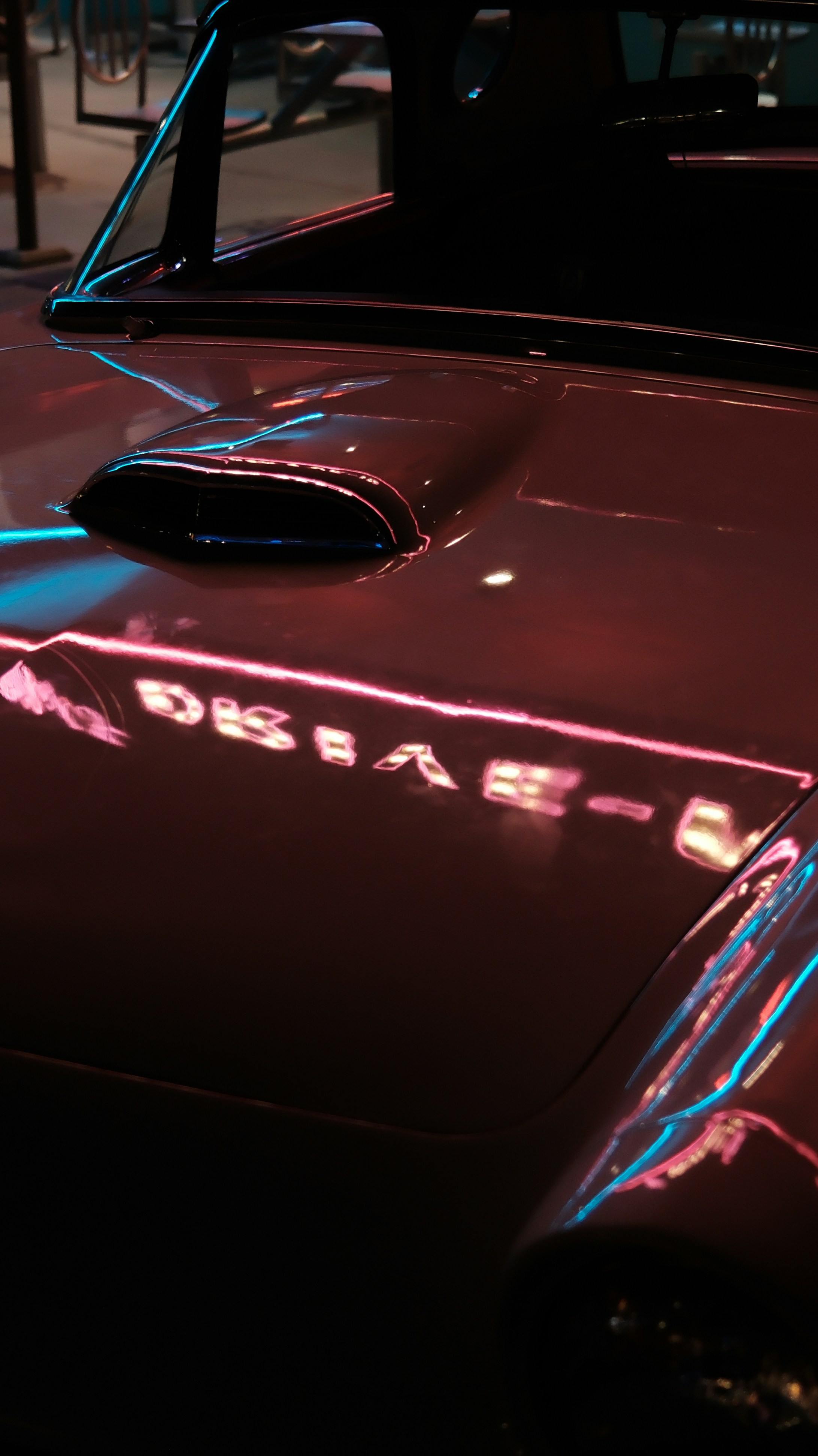 Neon Reflections on a Classic Hood