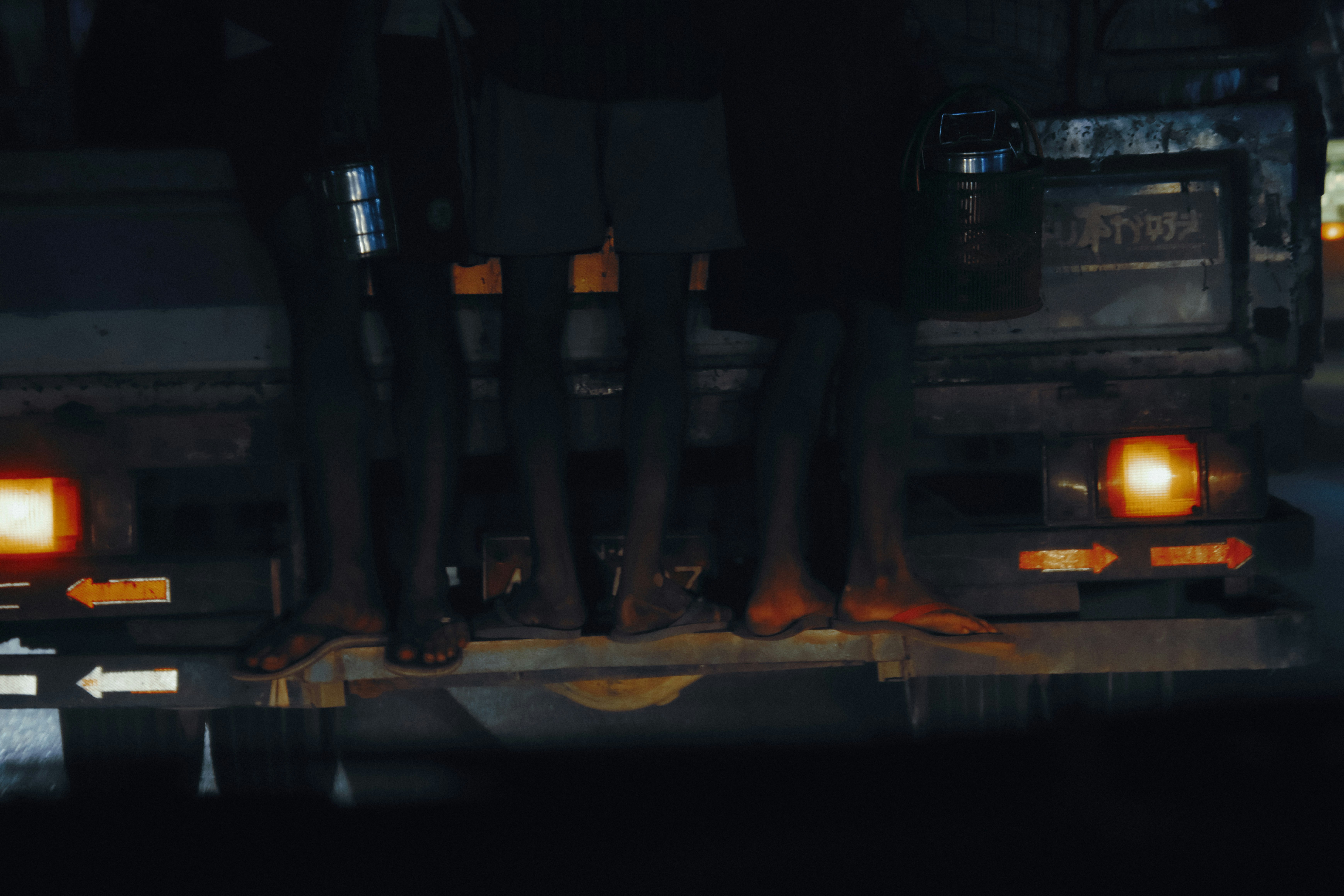 Underbelly of the Freight: Feet and Tires Beneath a Dark Cab