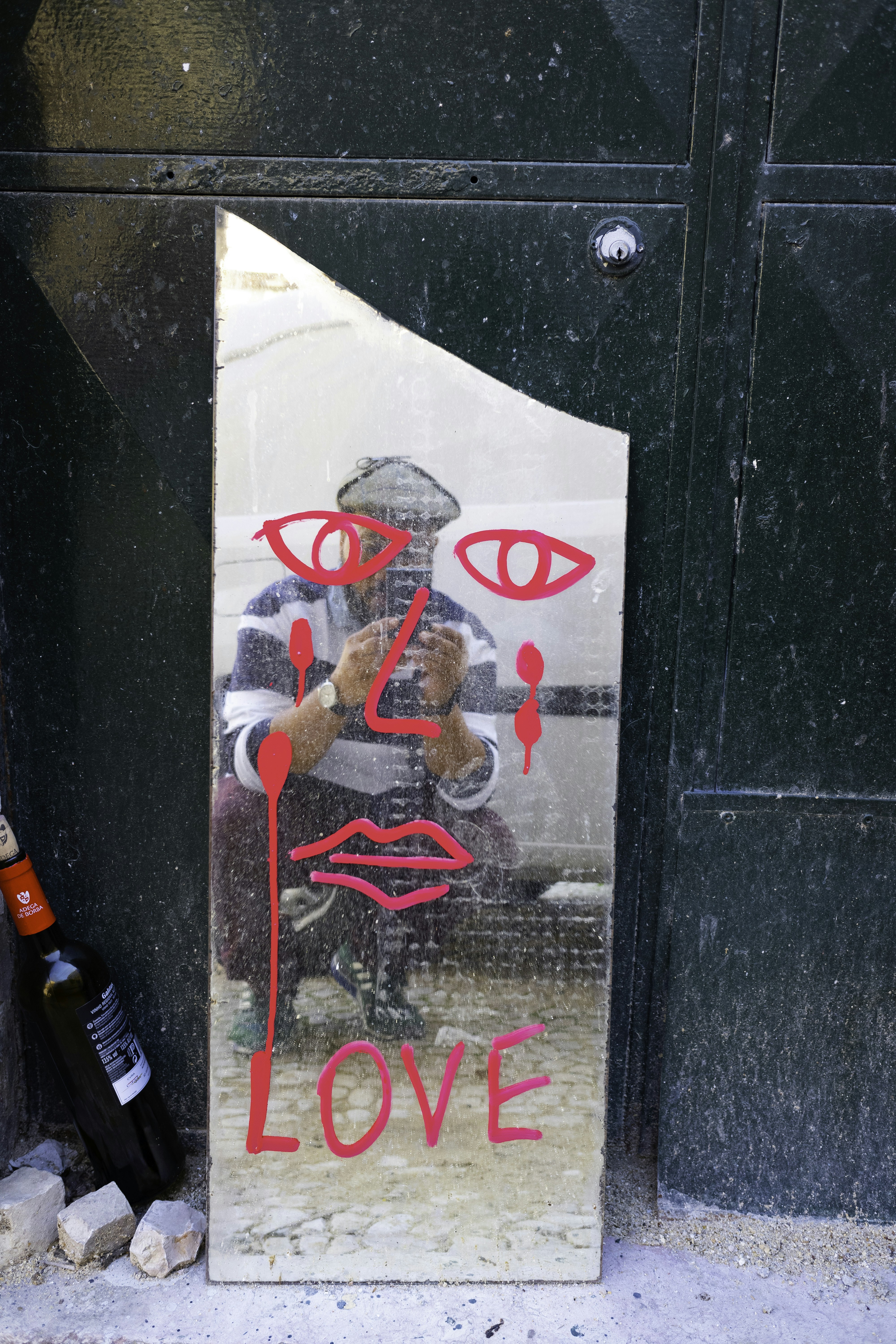 Mirror Graffiti: Love Stenciled on a Reflective Panel by the Door