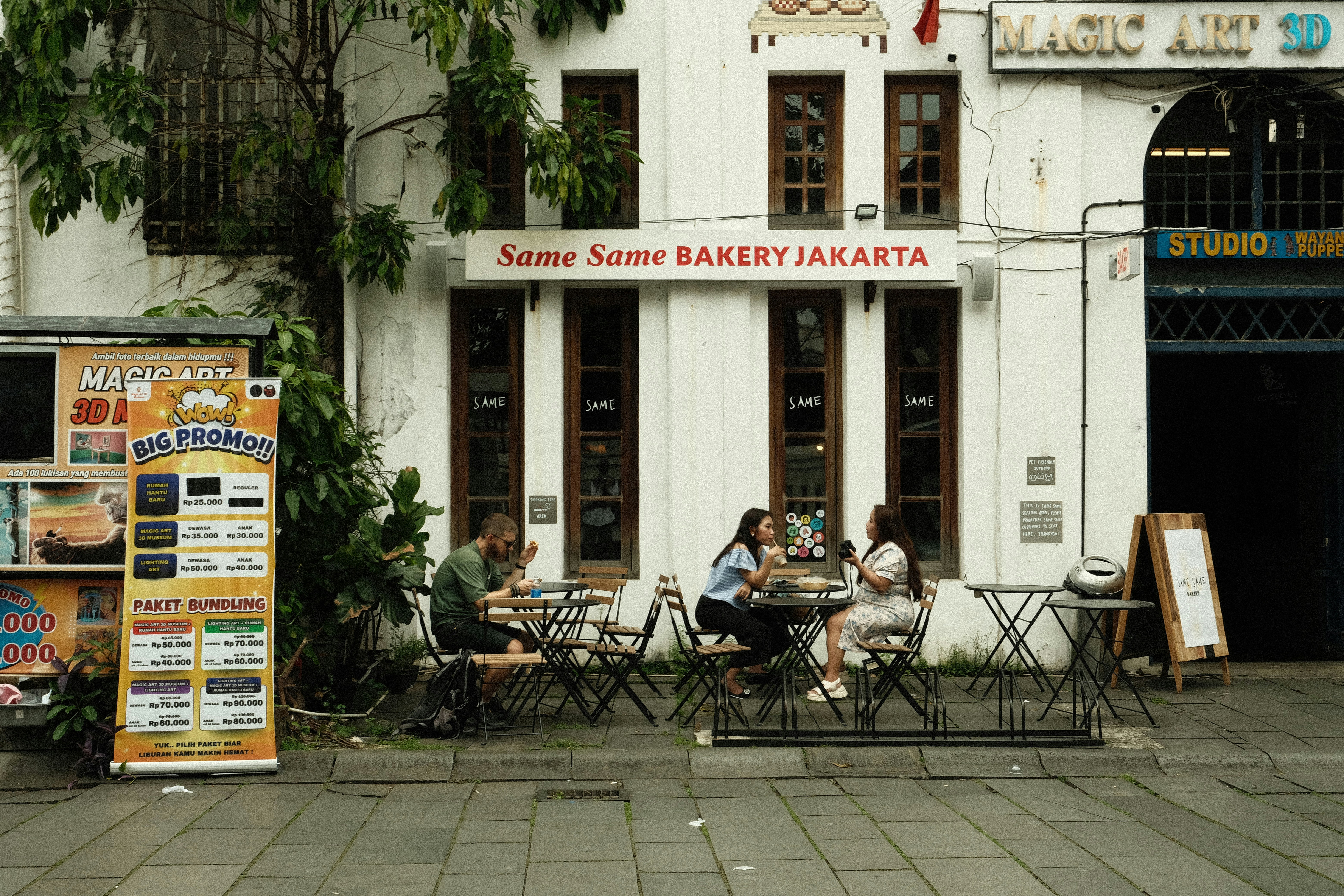 Cafe Terrace in Jakarta: A Quiet Moment Outside a White-Washed Bakery