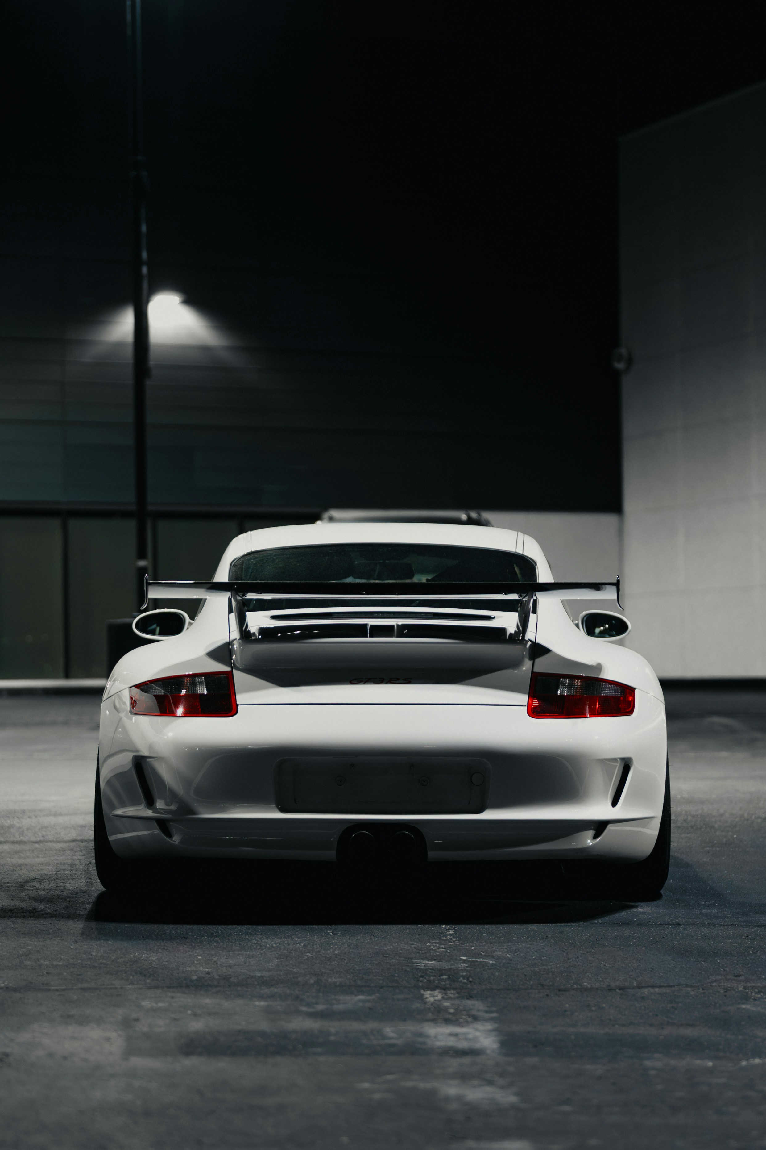 Rear-View Power: White Porsche in a Quiet Midnight Lot