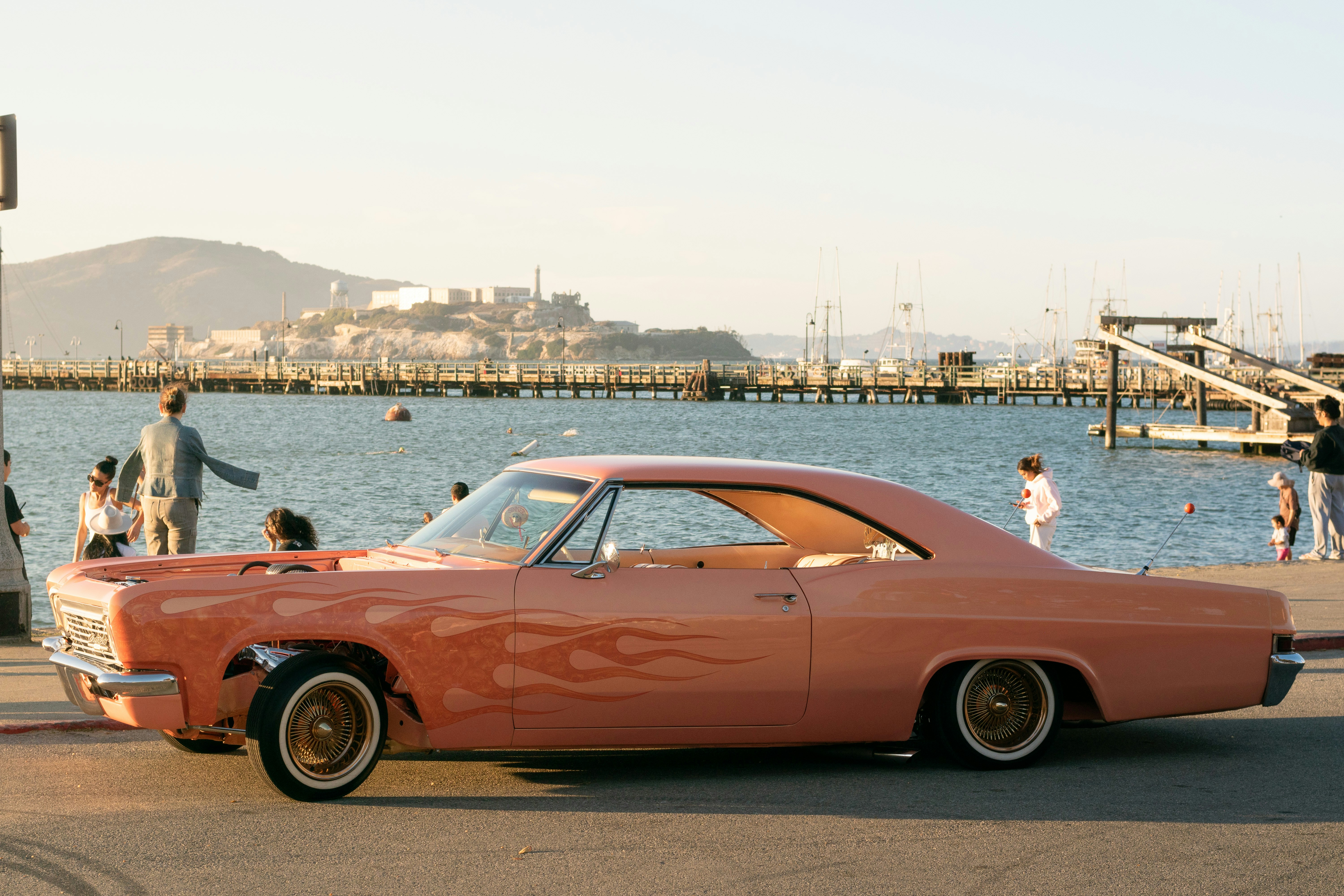 Sunlit Orange Classic: A Retro Car Anchors the Pierfront