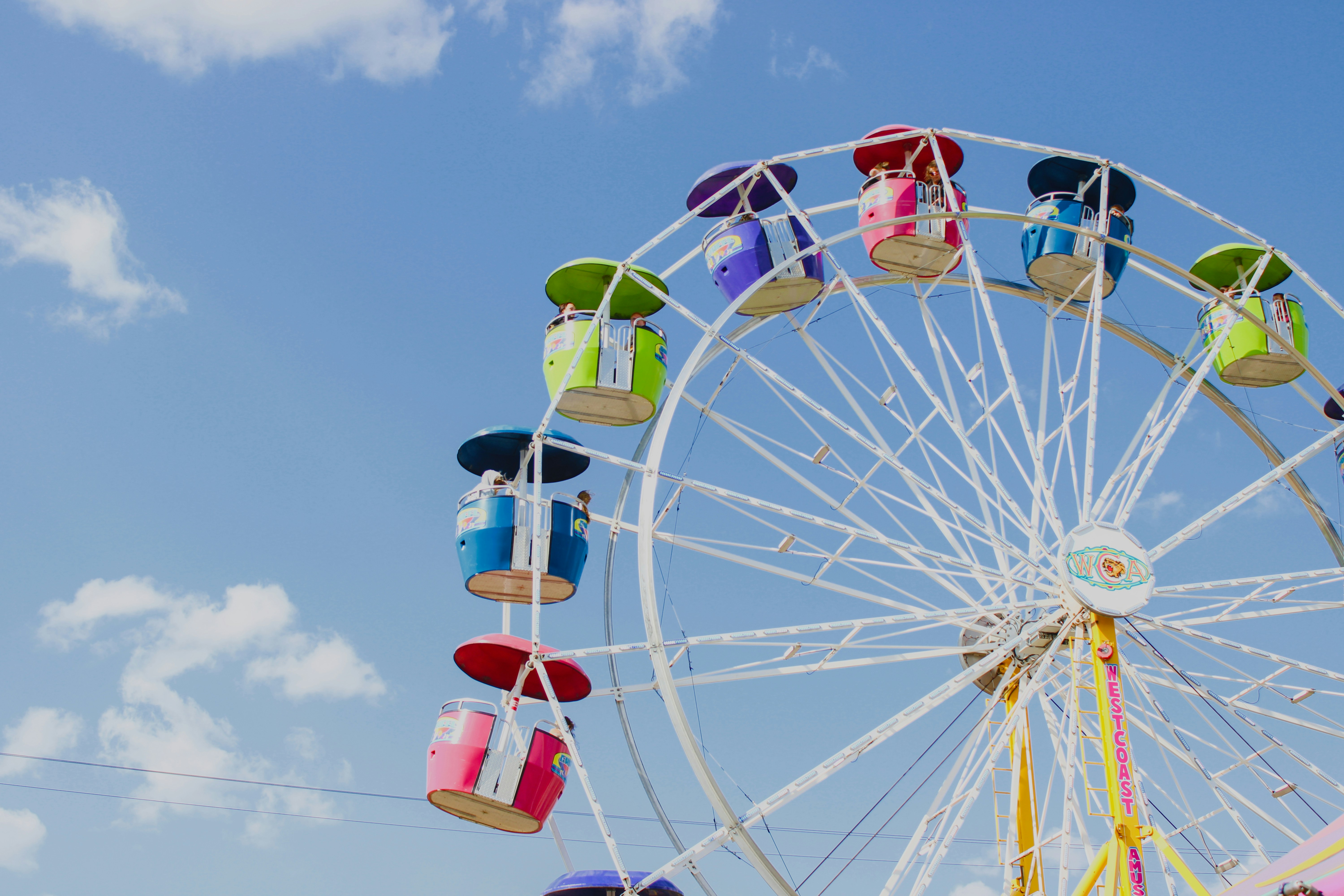 Skyward Carousel: Colors and Cables Against a Bright Blue Vista